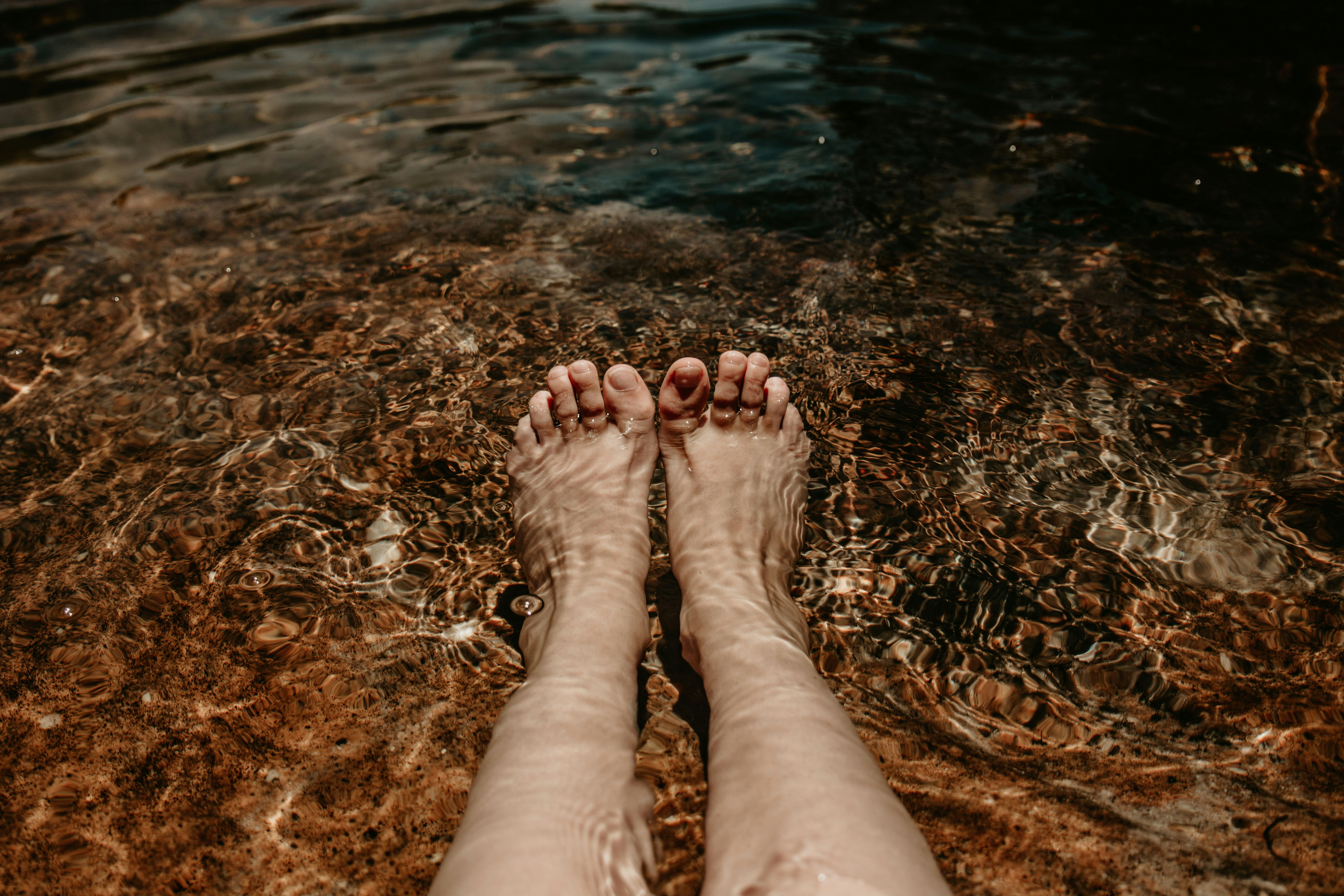 person's feet in waterClaudia Love
