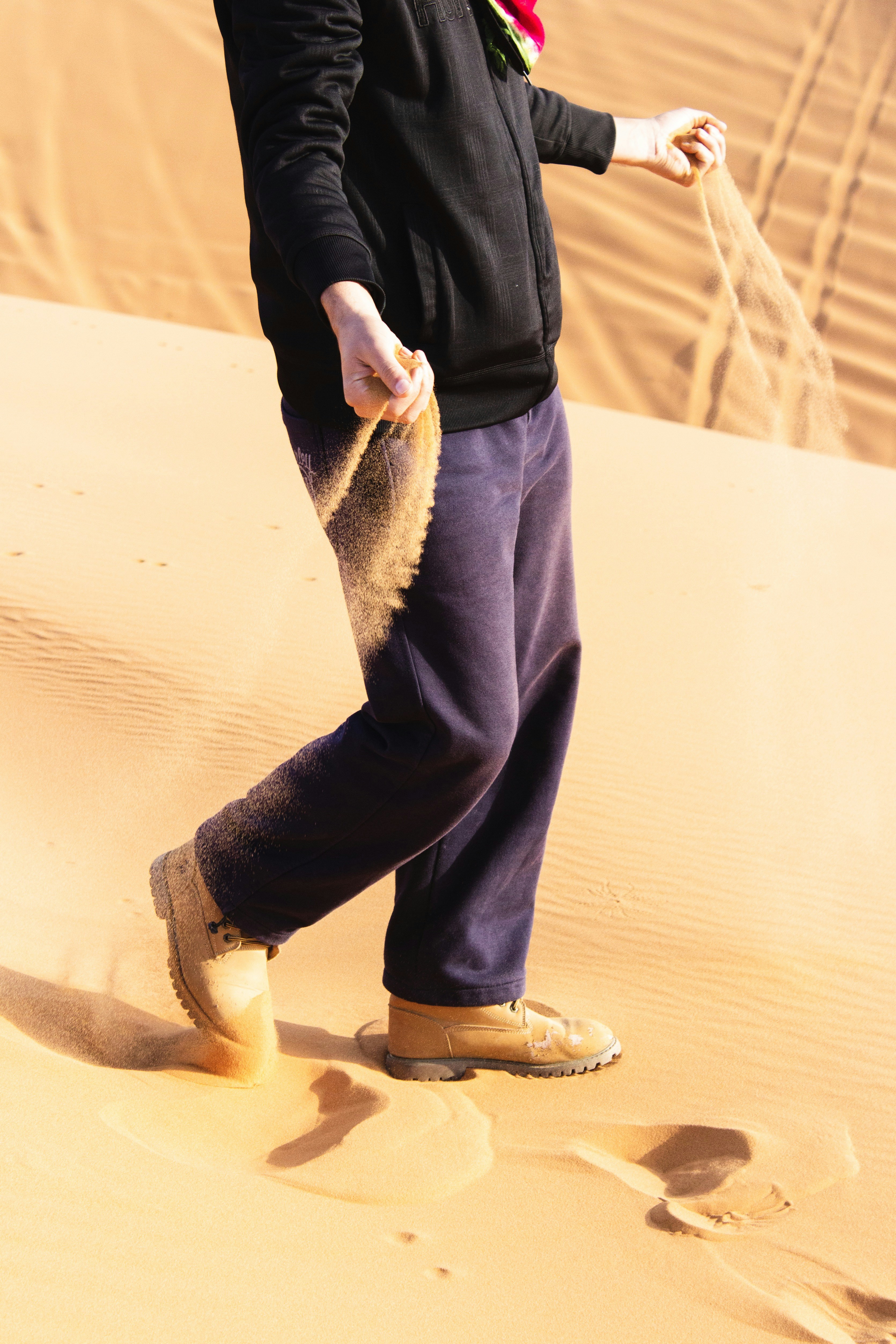 Desert Stride: Sand Toss and Quiet Motion Across Golden Dunes