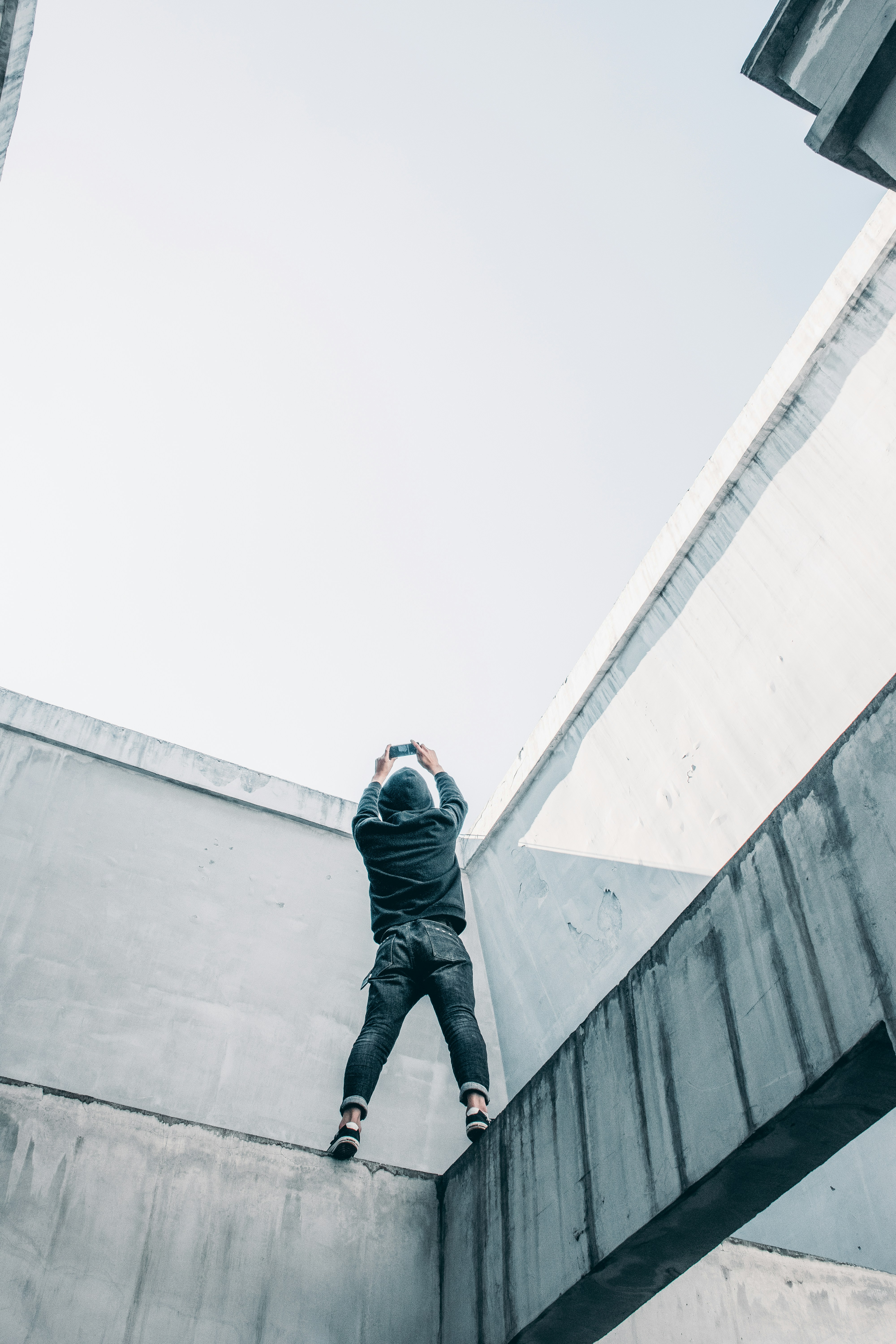Person standing on building photo – Free Purple Image on Unsplash