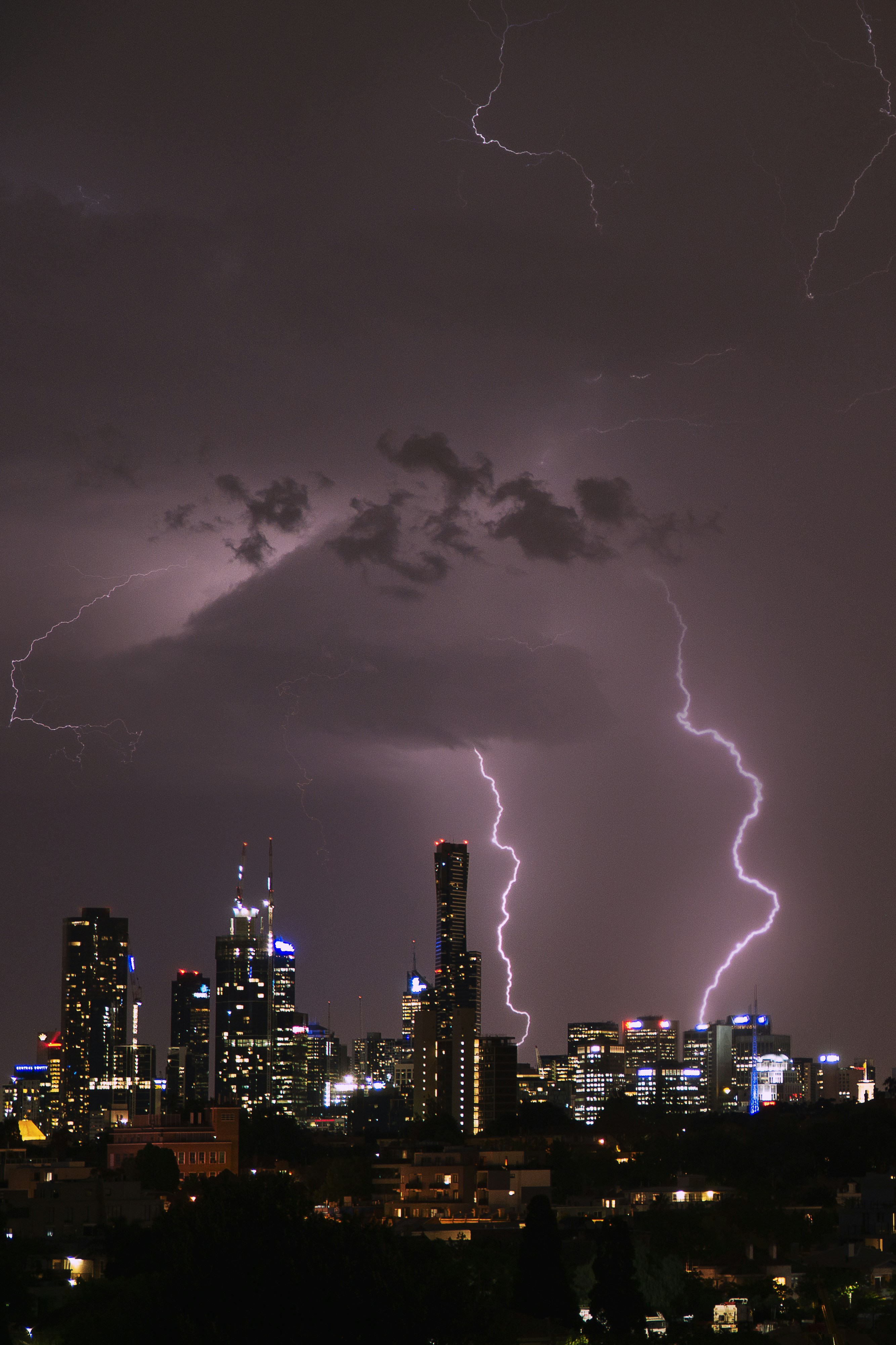 Time lapse photography of highrise building under lightning photo ...