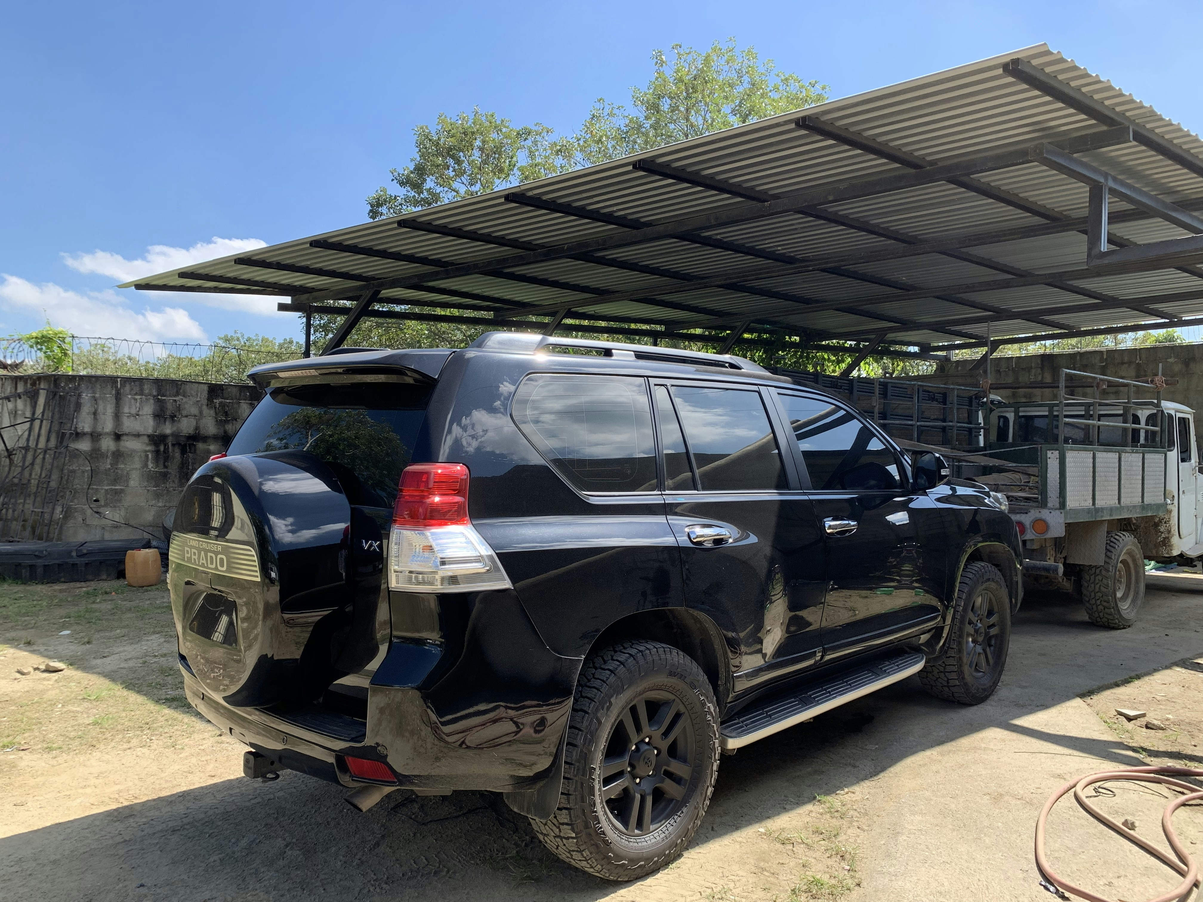 Black SUV parked under corrugated sheet photo – Free Vehicle Image on ...