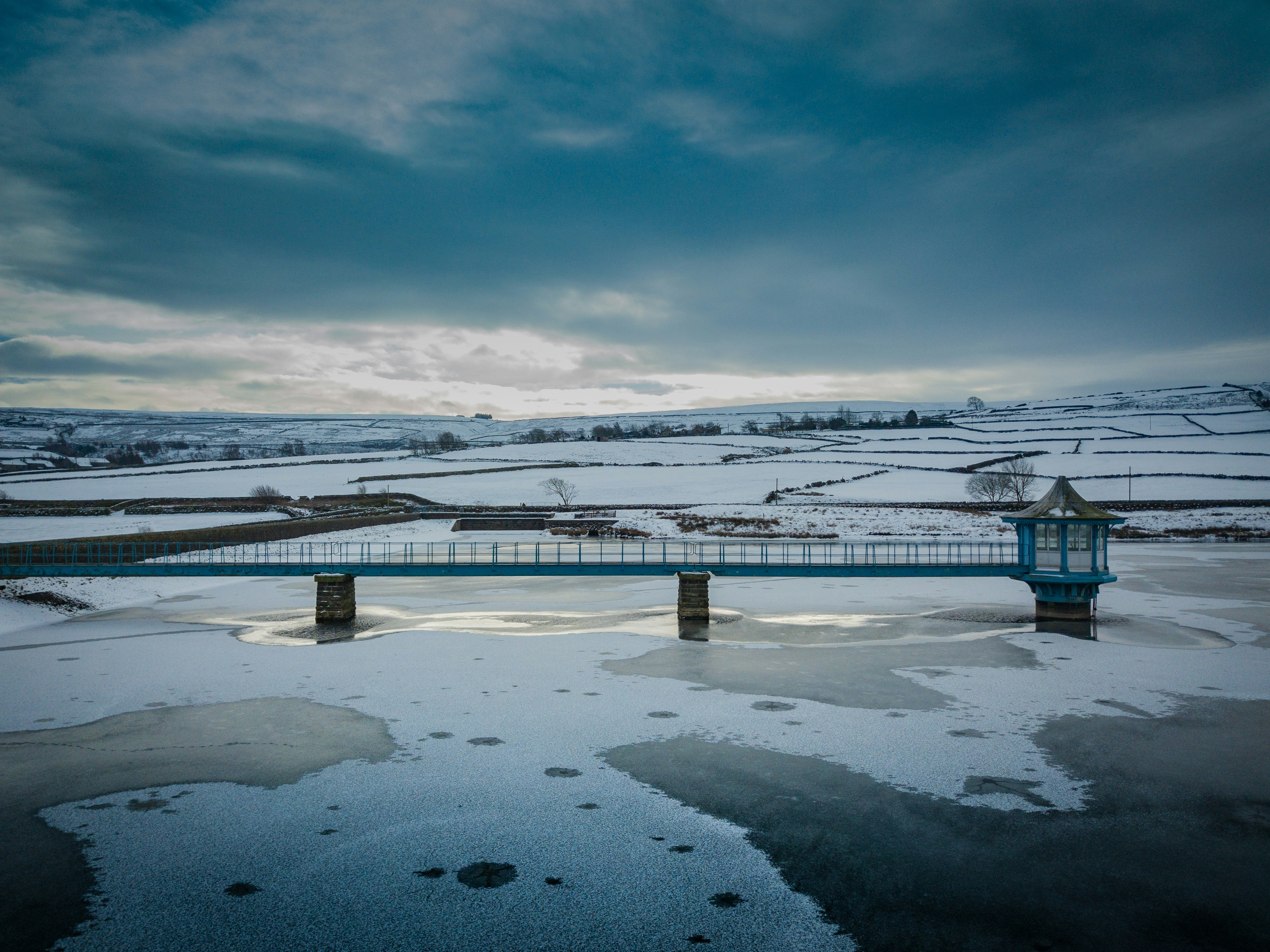 Blue Span on a White River: A Winter Landscape with a Lone Pavilion