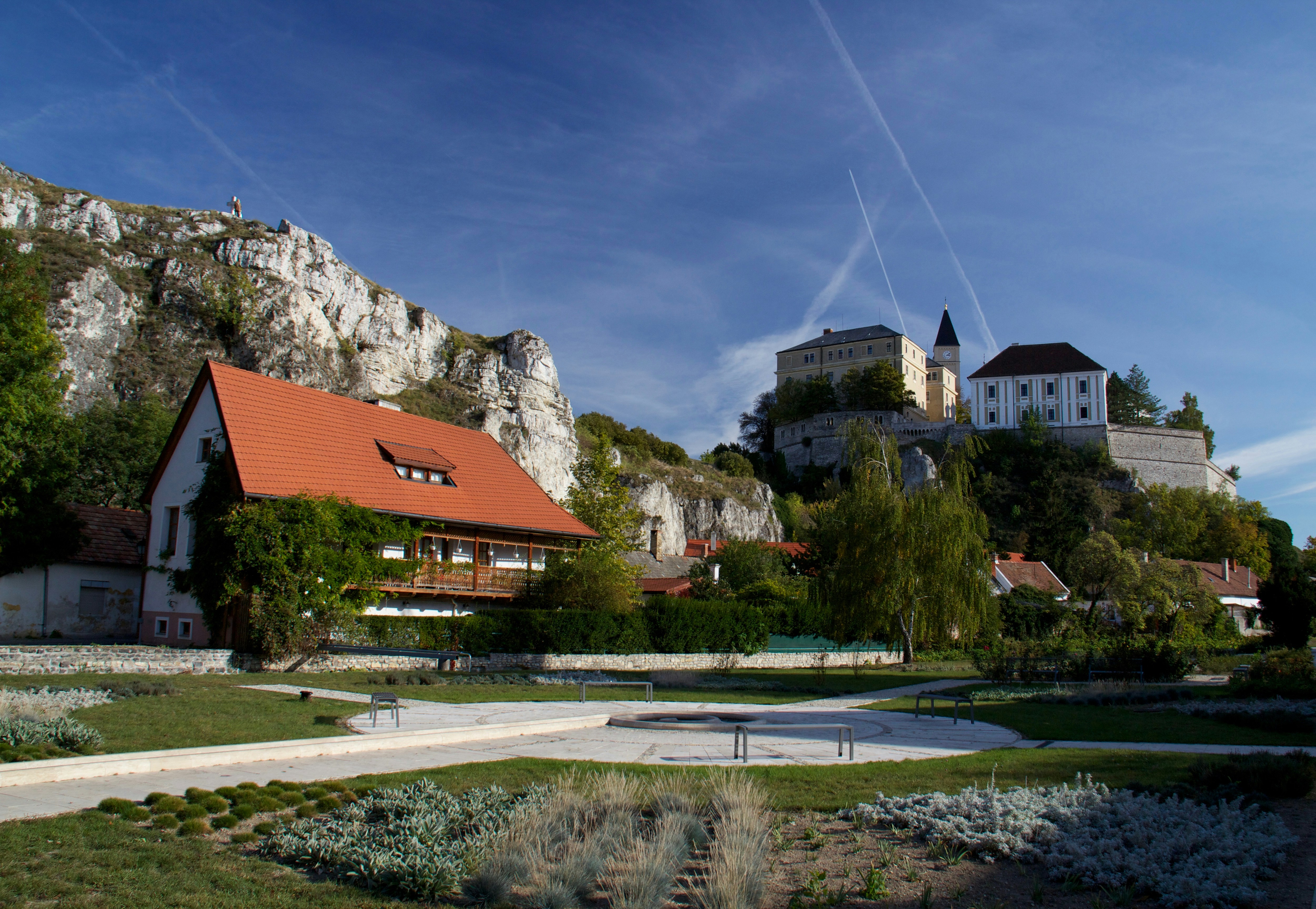 Cliffside Castle Overlooking a Red-Roofed Village