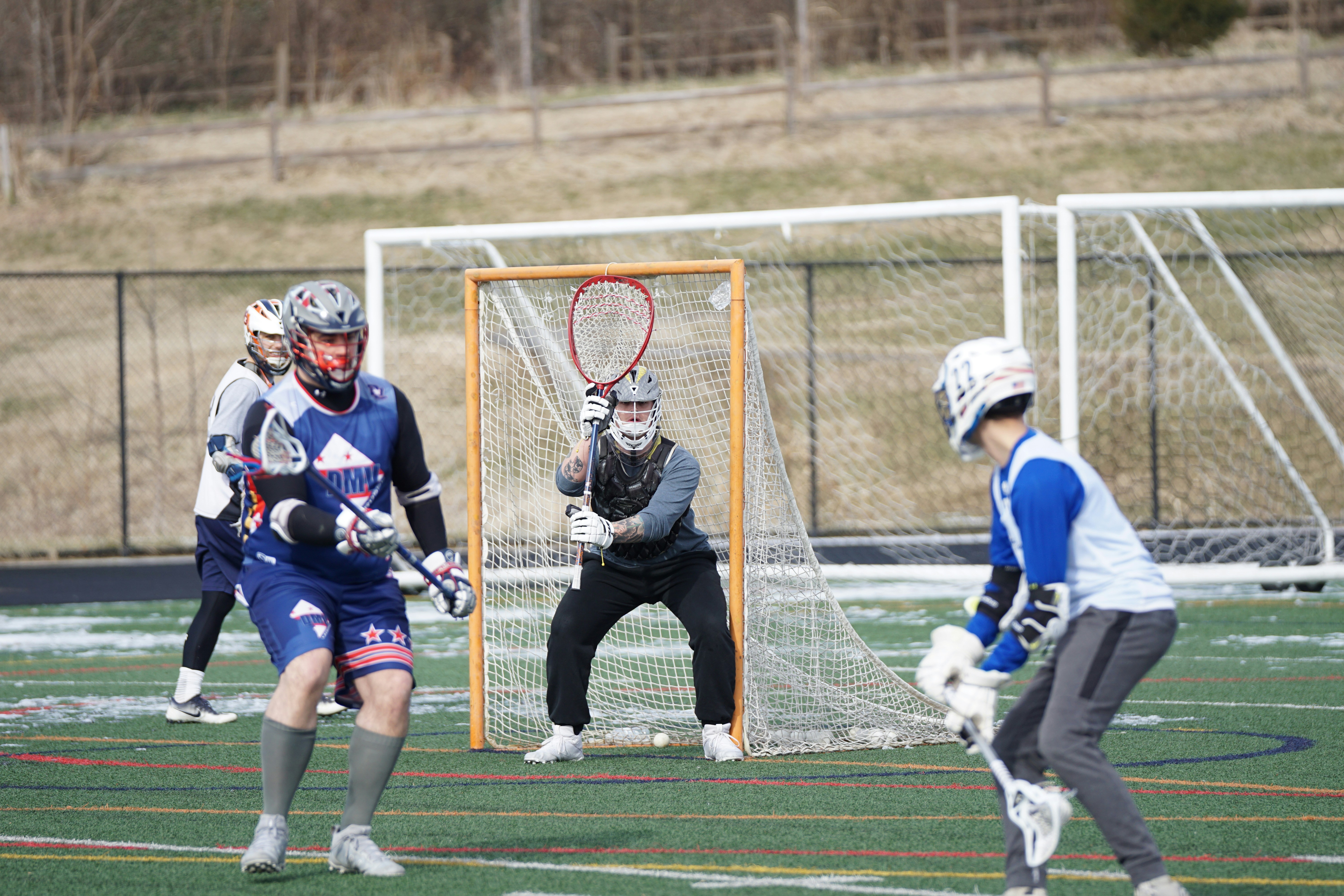 Crease Guardian: The Goalie Stands Ground Before the Oncoming Attack
