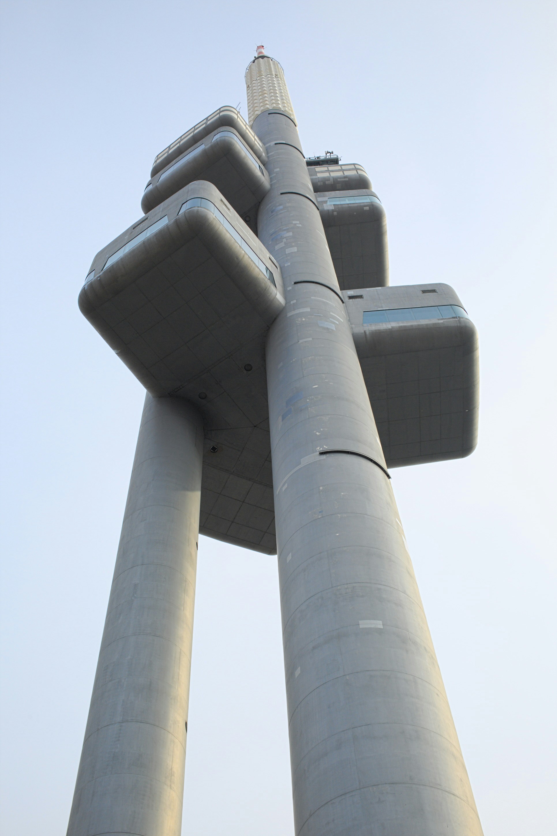 A modern architectural marvel featuring a towering structure with cantilevered observation pods against a clear sky.