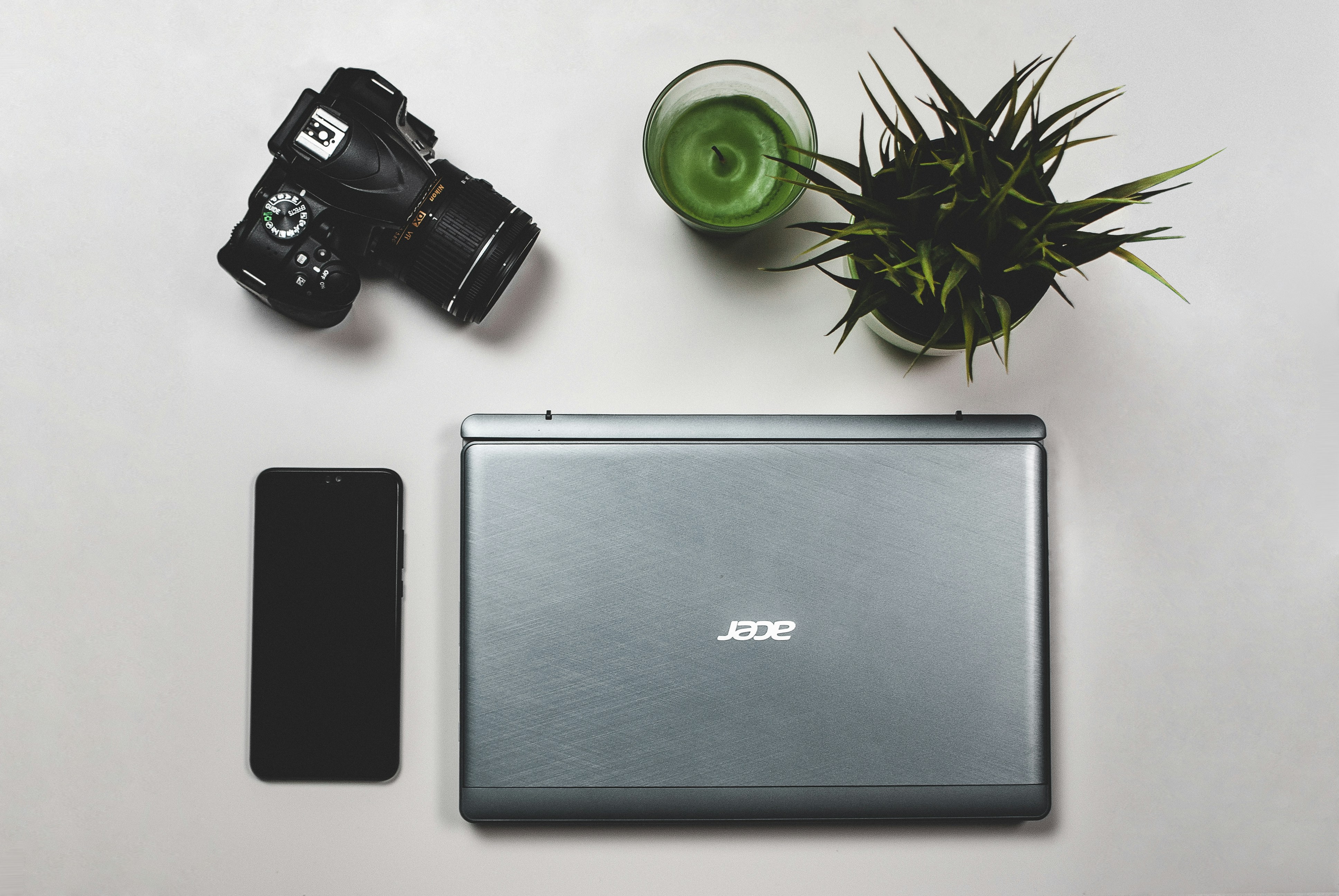 Grey Acer laptop beside black smartphone and black DSLR camera photo ...