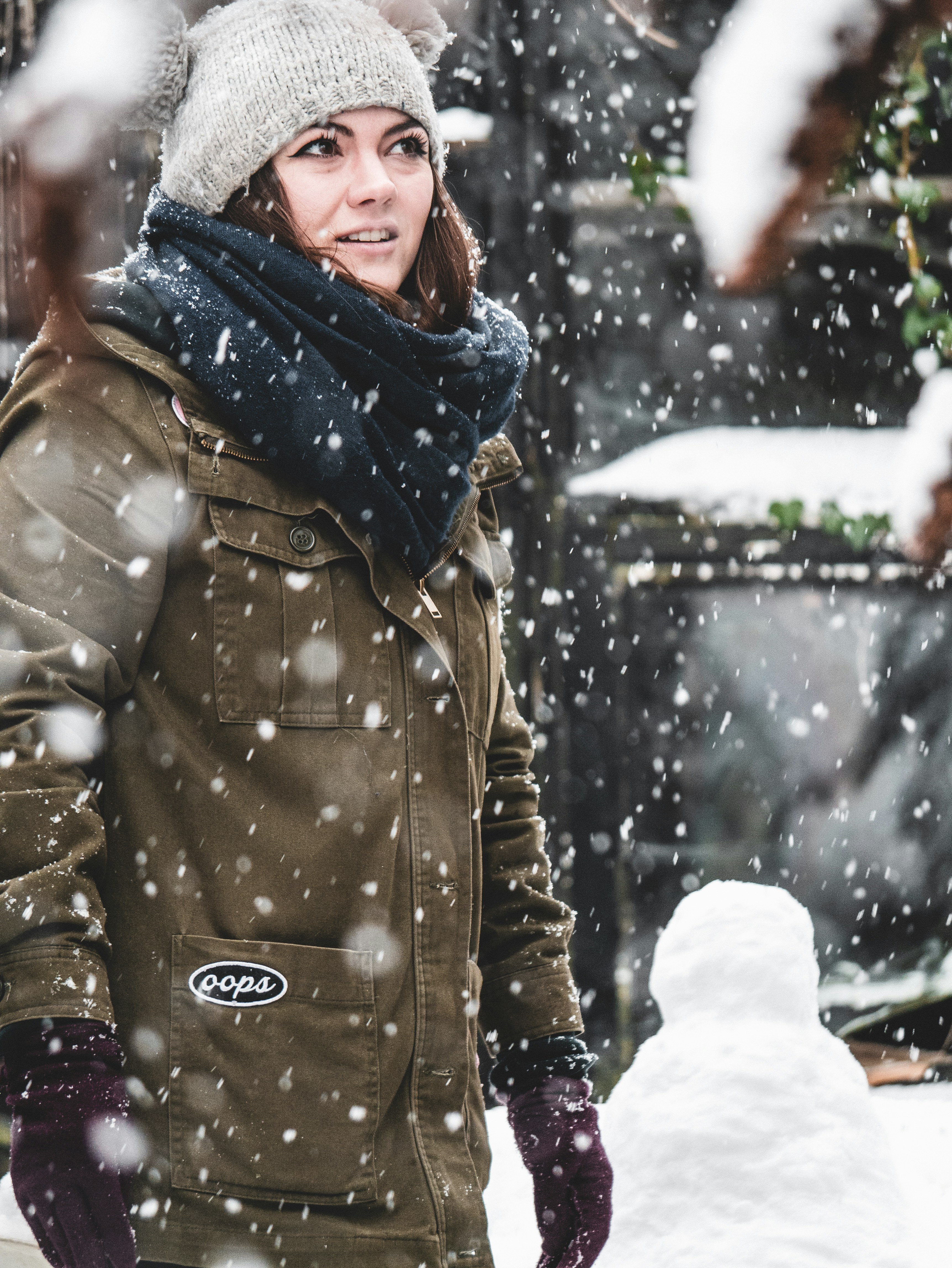 Woman standing in field covered with snow and snow dropping down photo ...