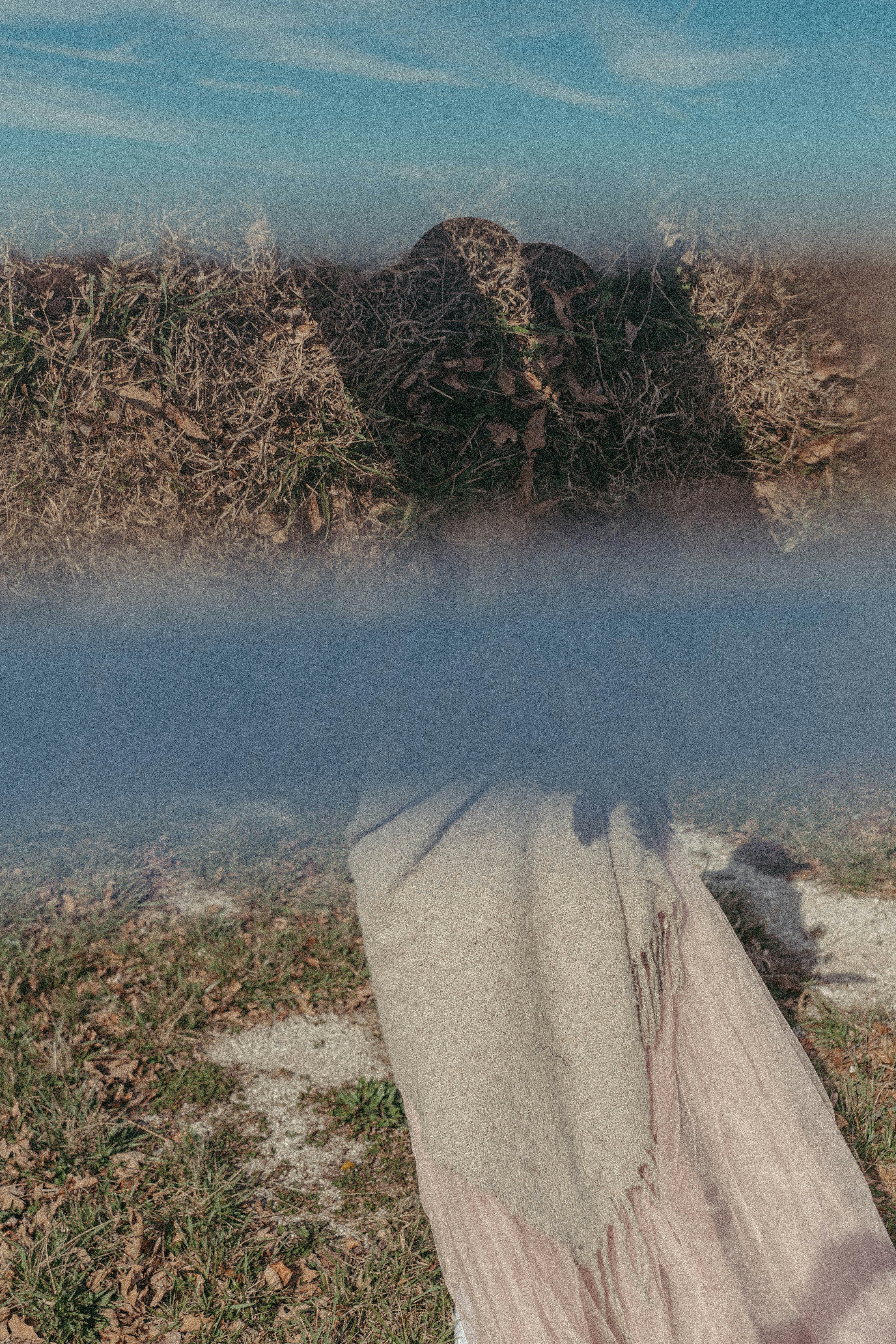 Pale-Gown Silhouette at the Edge of a Ruinous Hedge, Split by a Glassy Horizon