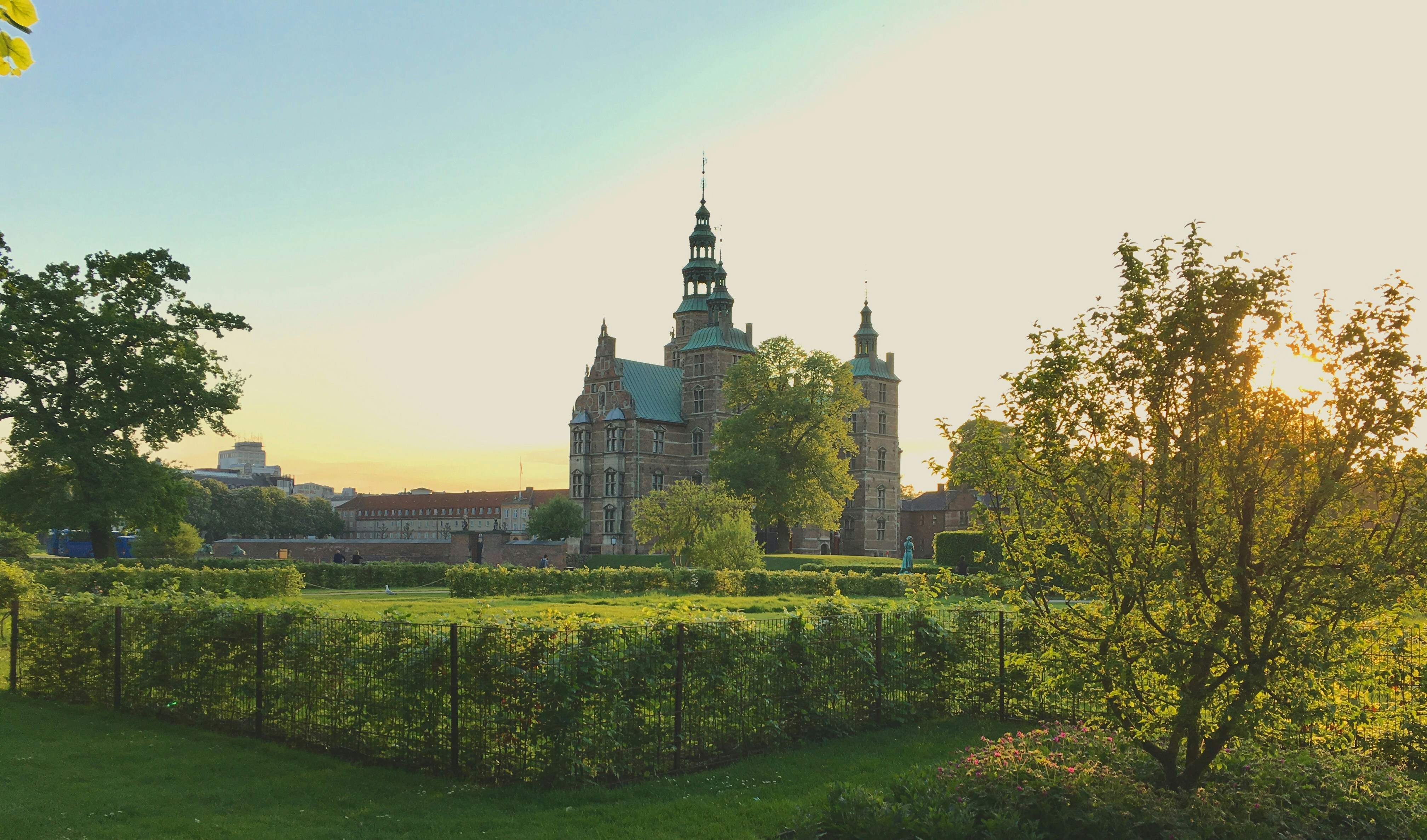 Sunlit Domes: A Riverside Castle Under Evening Gold