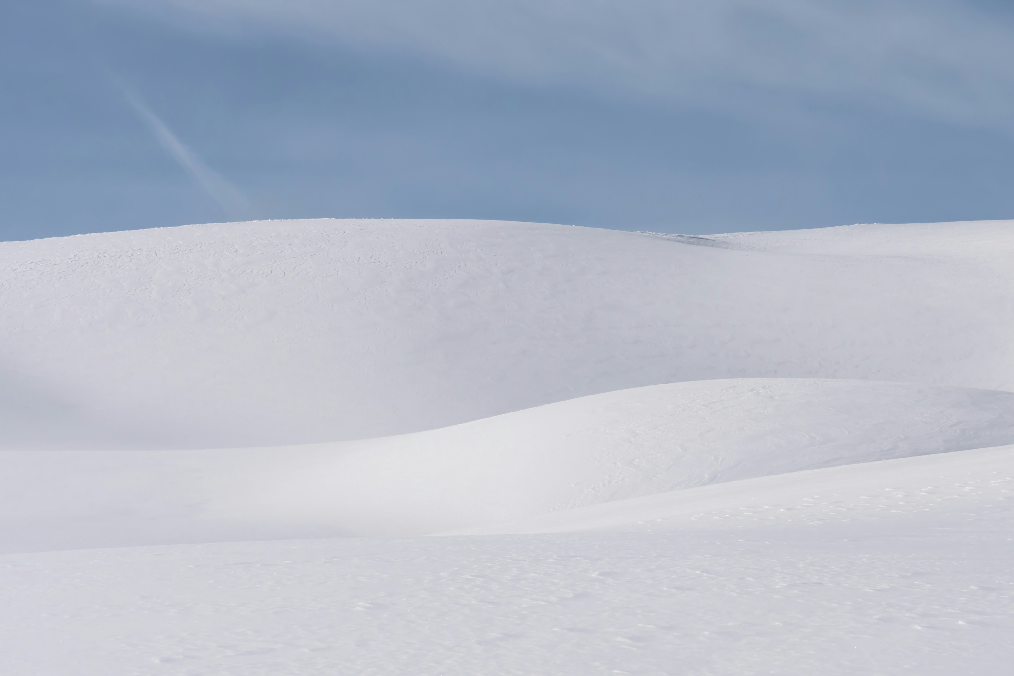Snow hills | a man riding skis down a snow covered slope