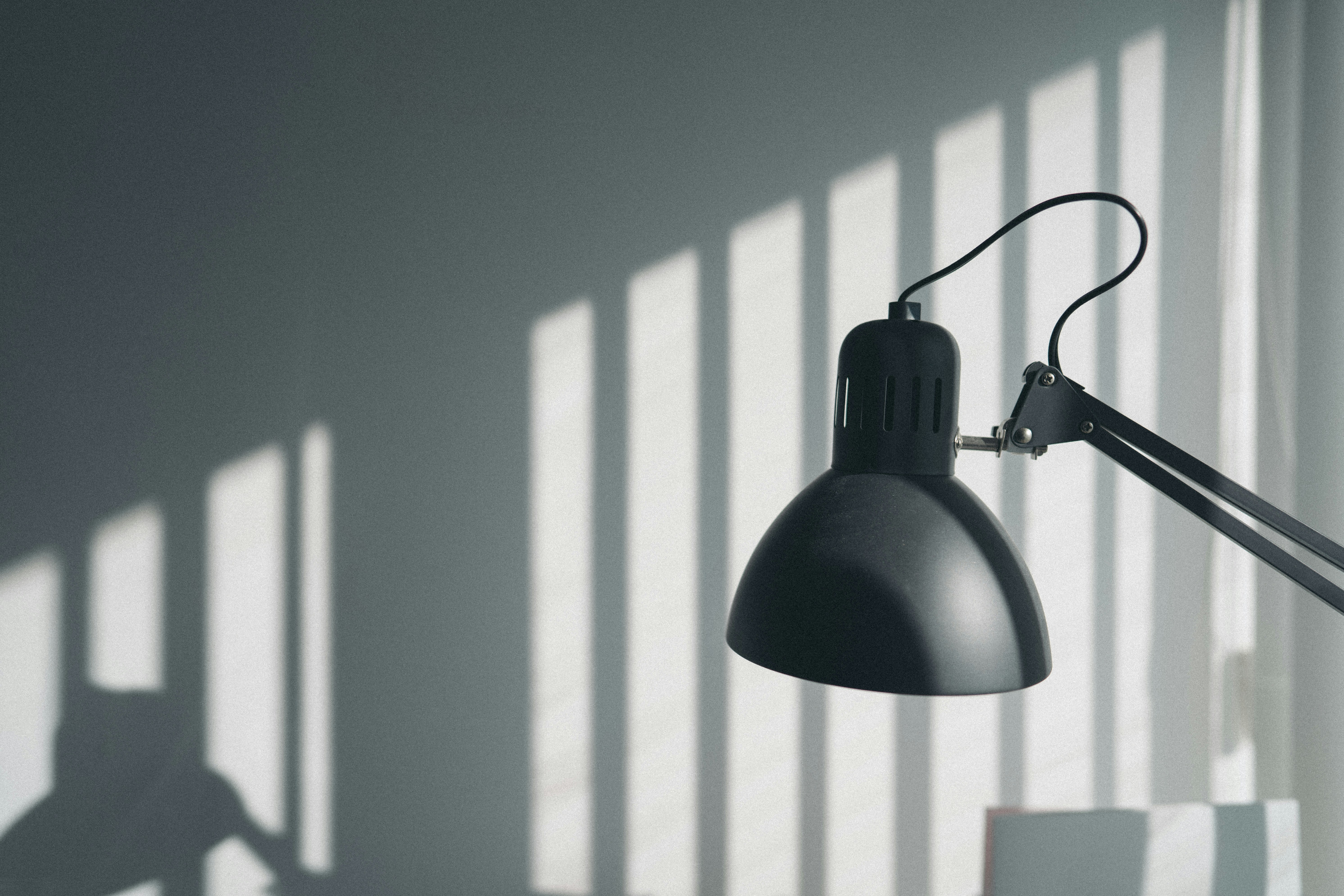 Lamplight Between Slats: A Quiet Desk Scene