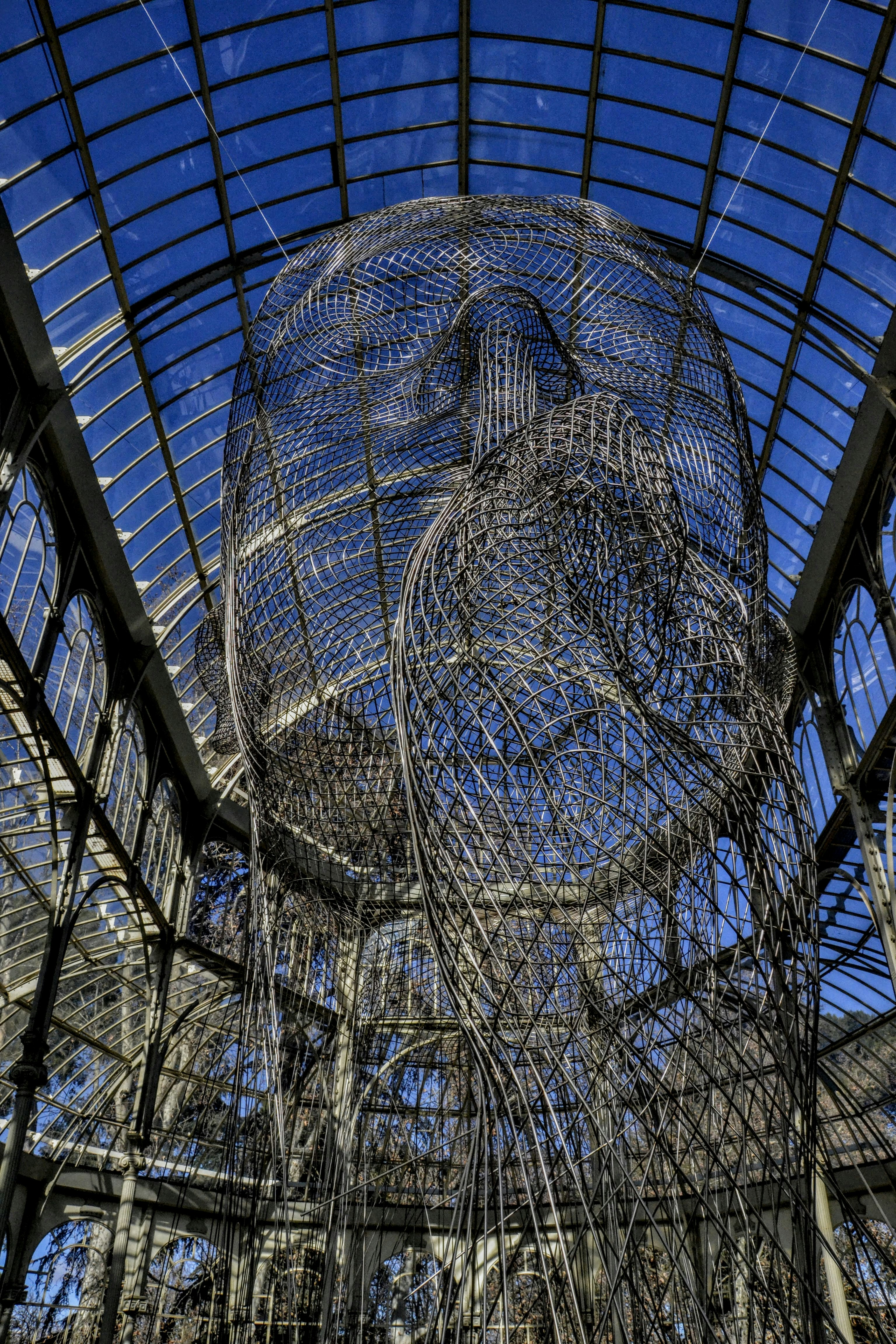 gray metal mesh under blue arch glass roof