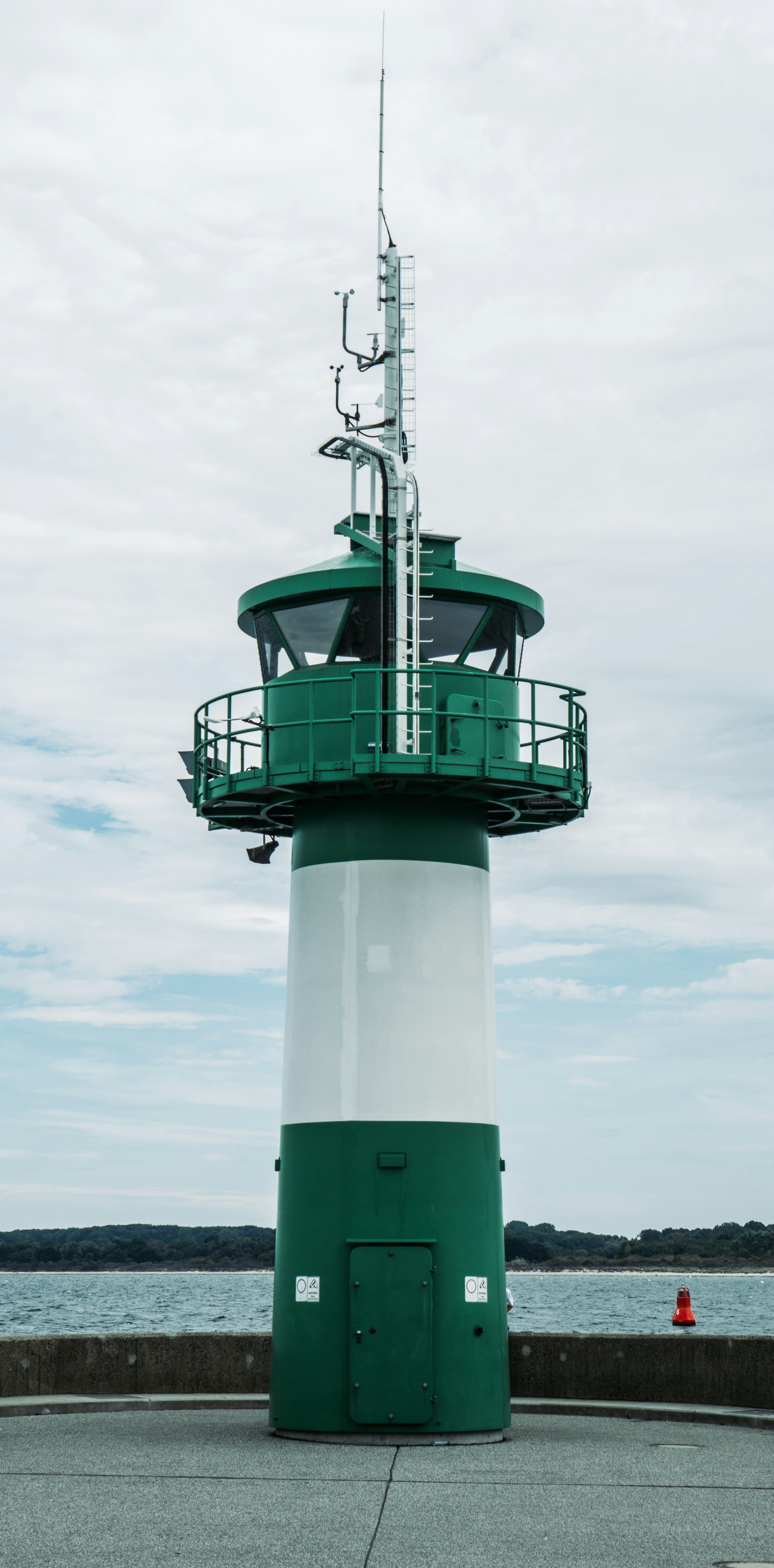 Green and white lighthouse near body of water photo – Free Sea Image on ...