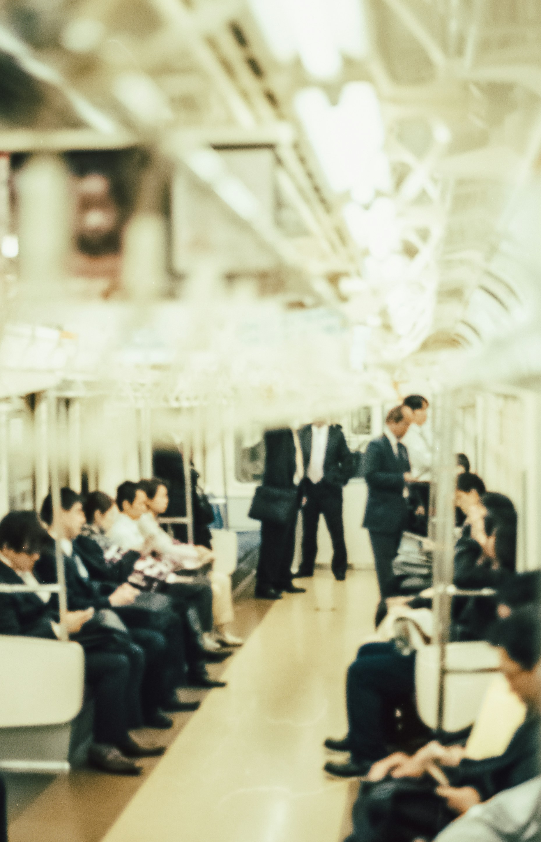 Crowded subway interior featuring commuters absorbed in their own worlds, with two individuals engaged in conversation. 