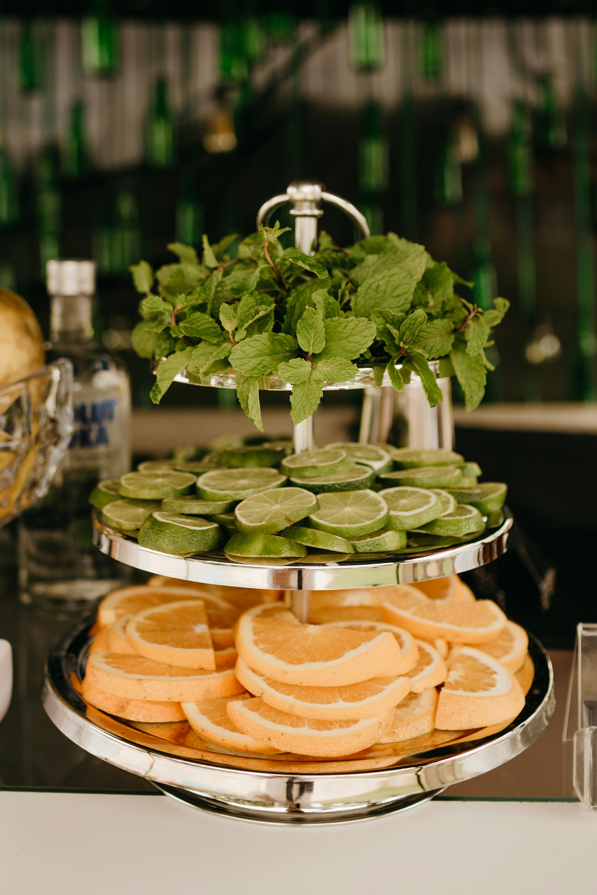 Mint Crowned Carousel: Limes and Oranges Layered on a Gleaming Bar Stand
