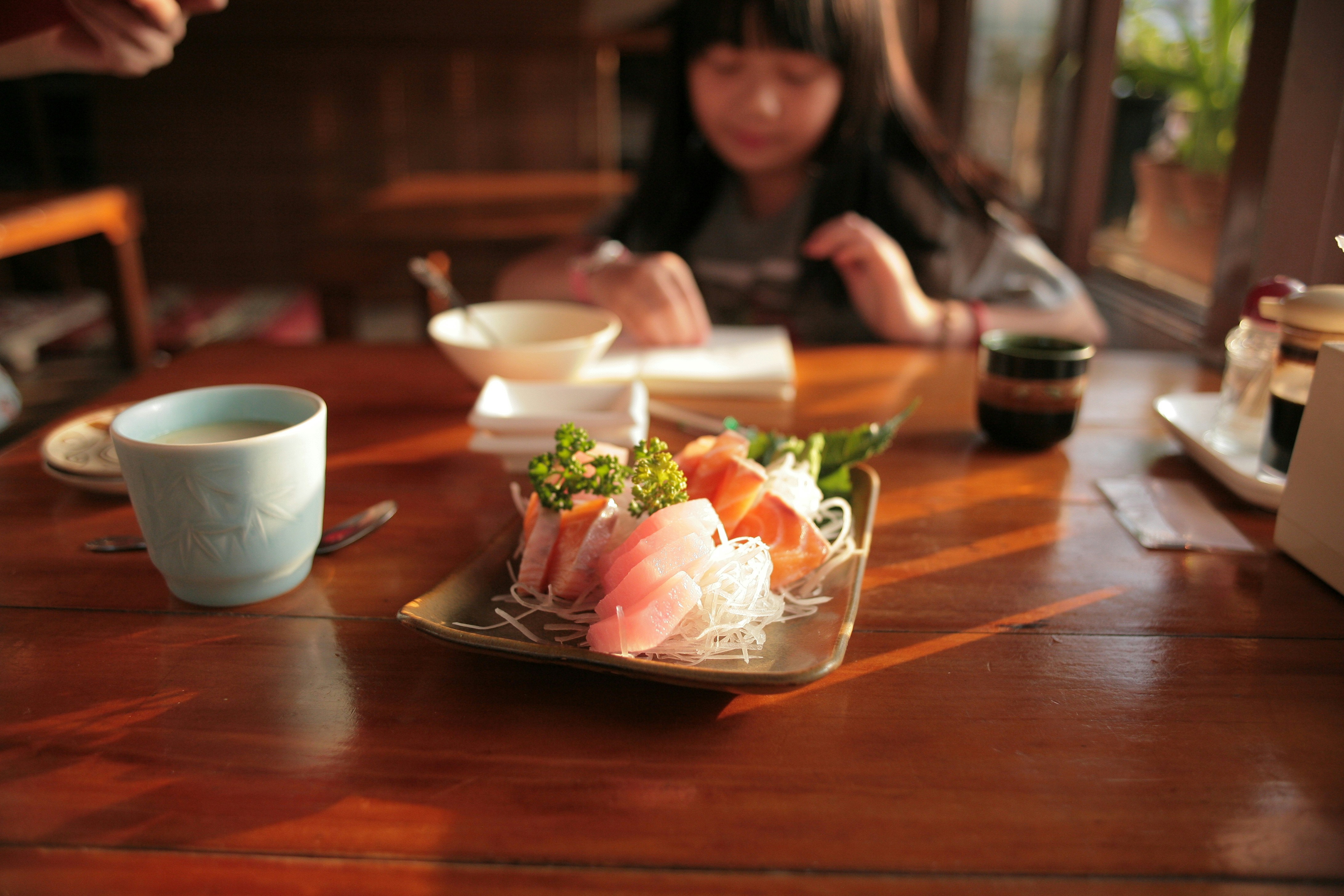 Sashimi in Focus on a Glowing Wooden Table