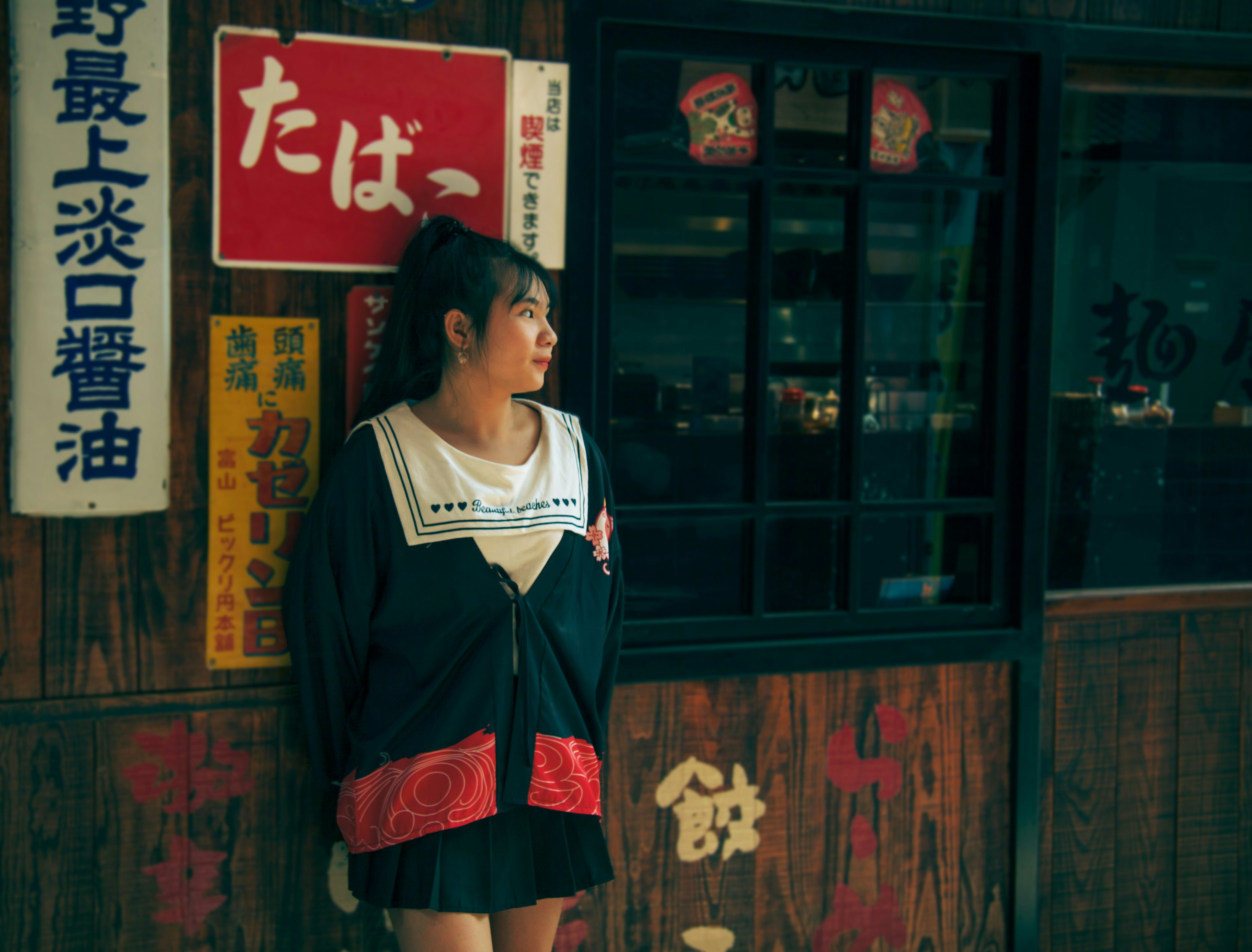 Weathered Wall Portrait: A Schoolgirl at a Sign-Filled Japanese Alley