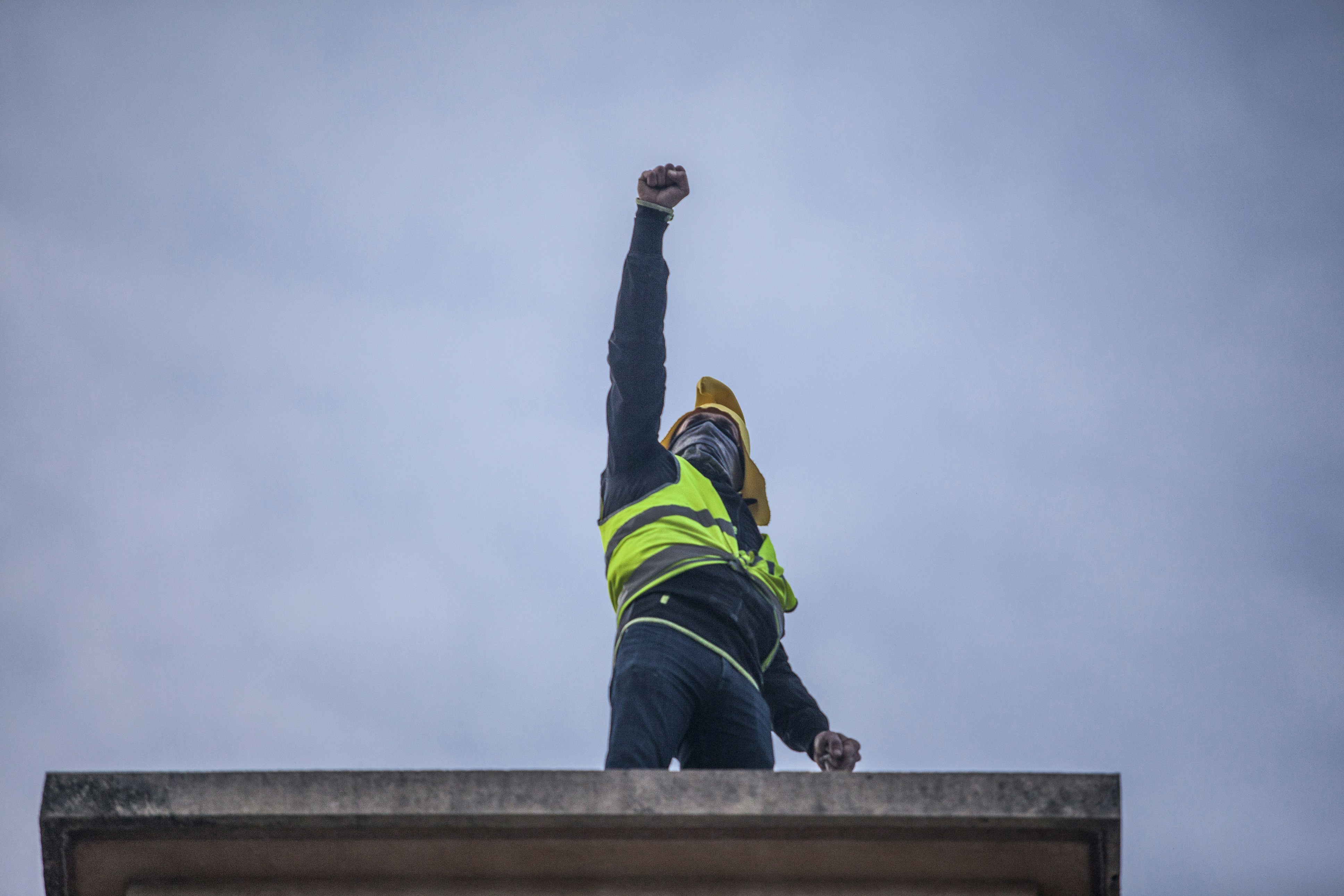 Person raising right arm photo – Free Building Image on Unsplash
