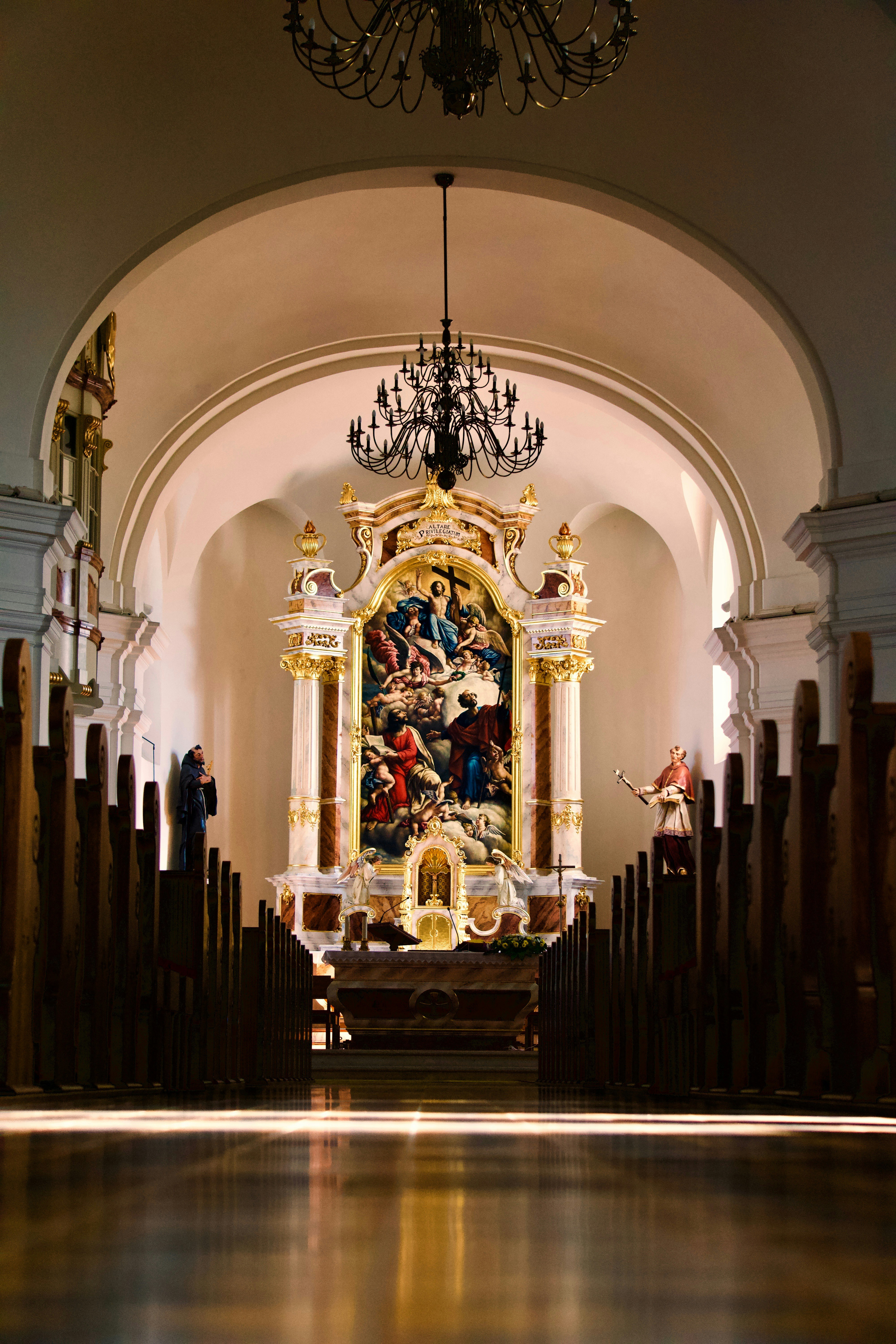 Chandelier and pew chairs inside facing altar inside church photo ...