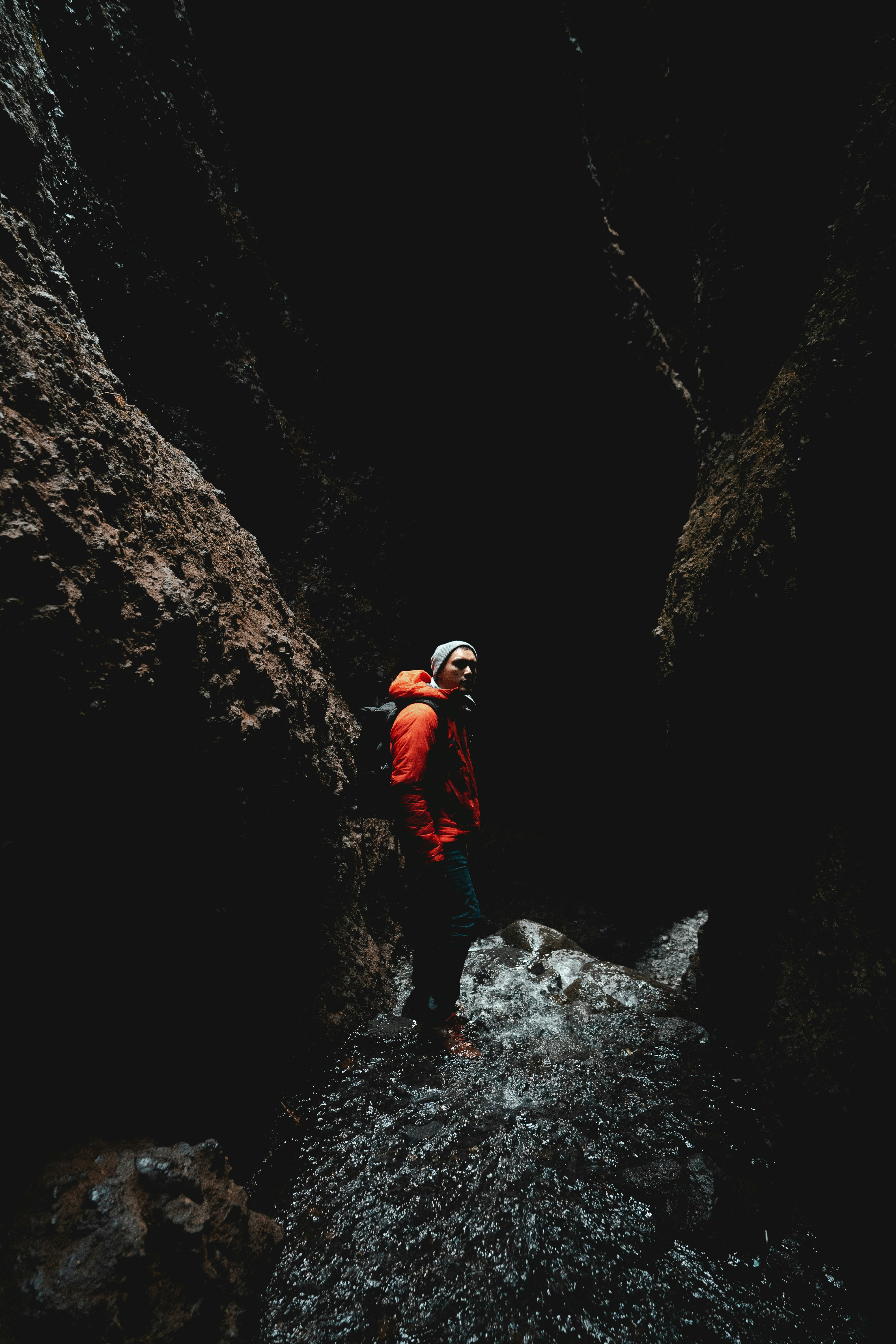Inside a Gorge in Iceland | man standing between rock formation during daytime