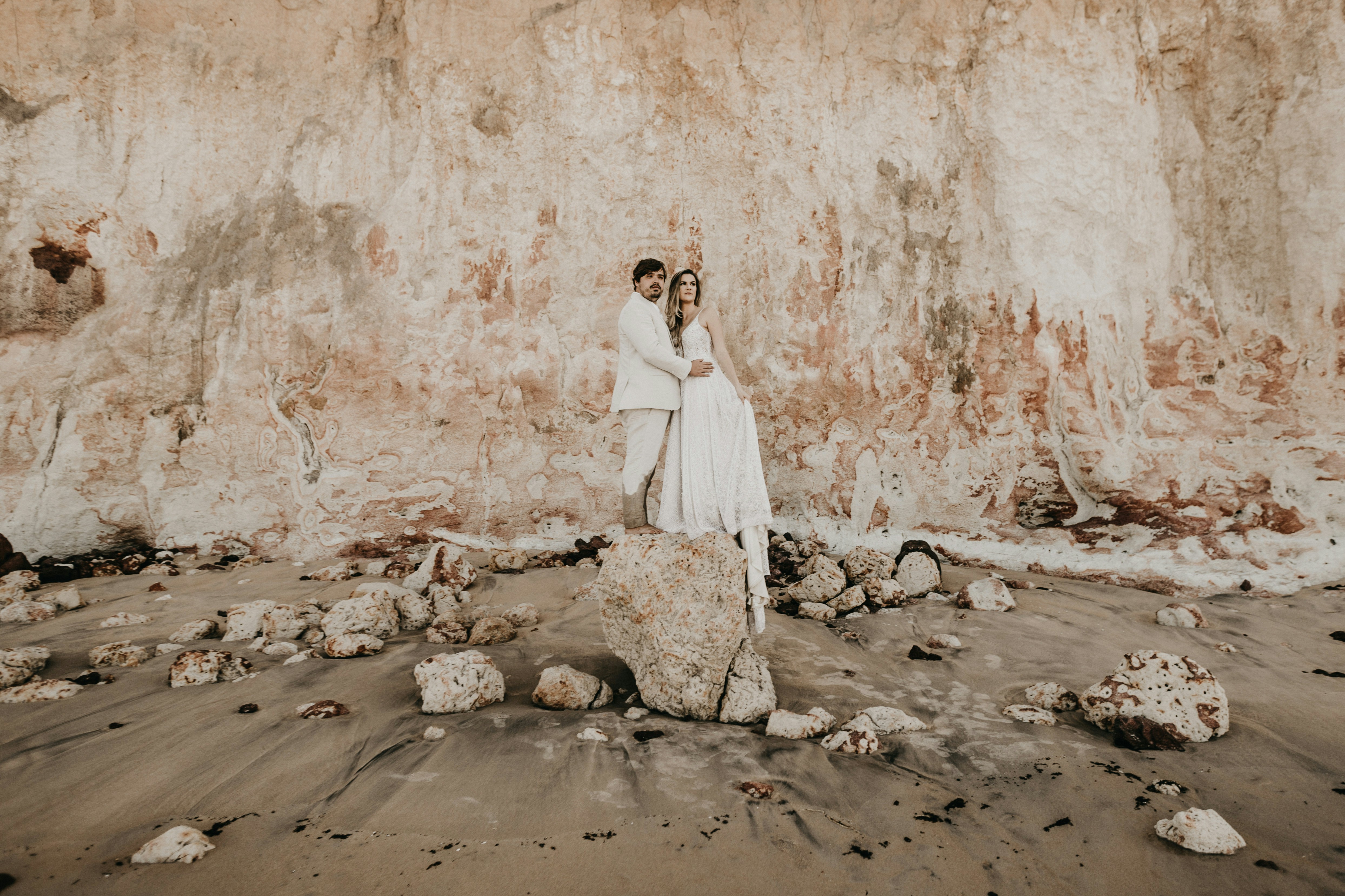 Man and woman standing front of rock formation photo – Free Wedding ...