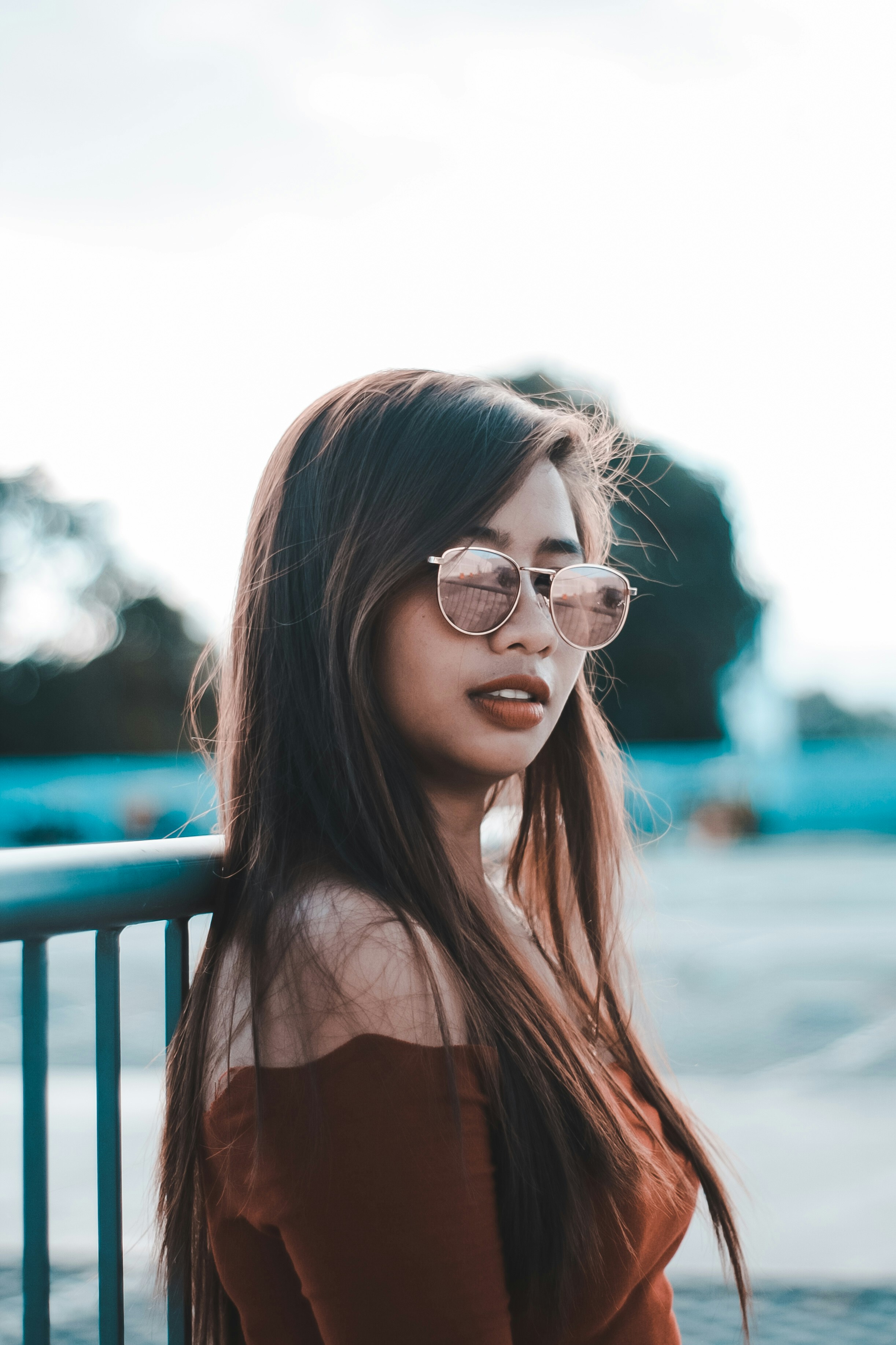 Woman leaning on rails photo – Free Human Image on Unsplash