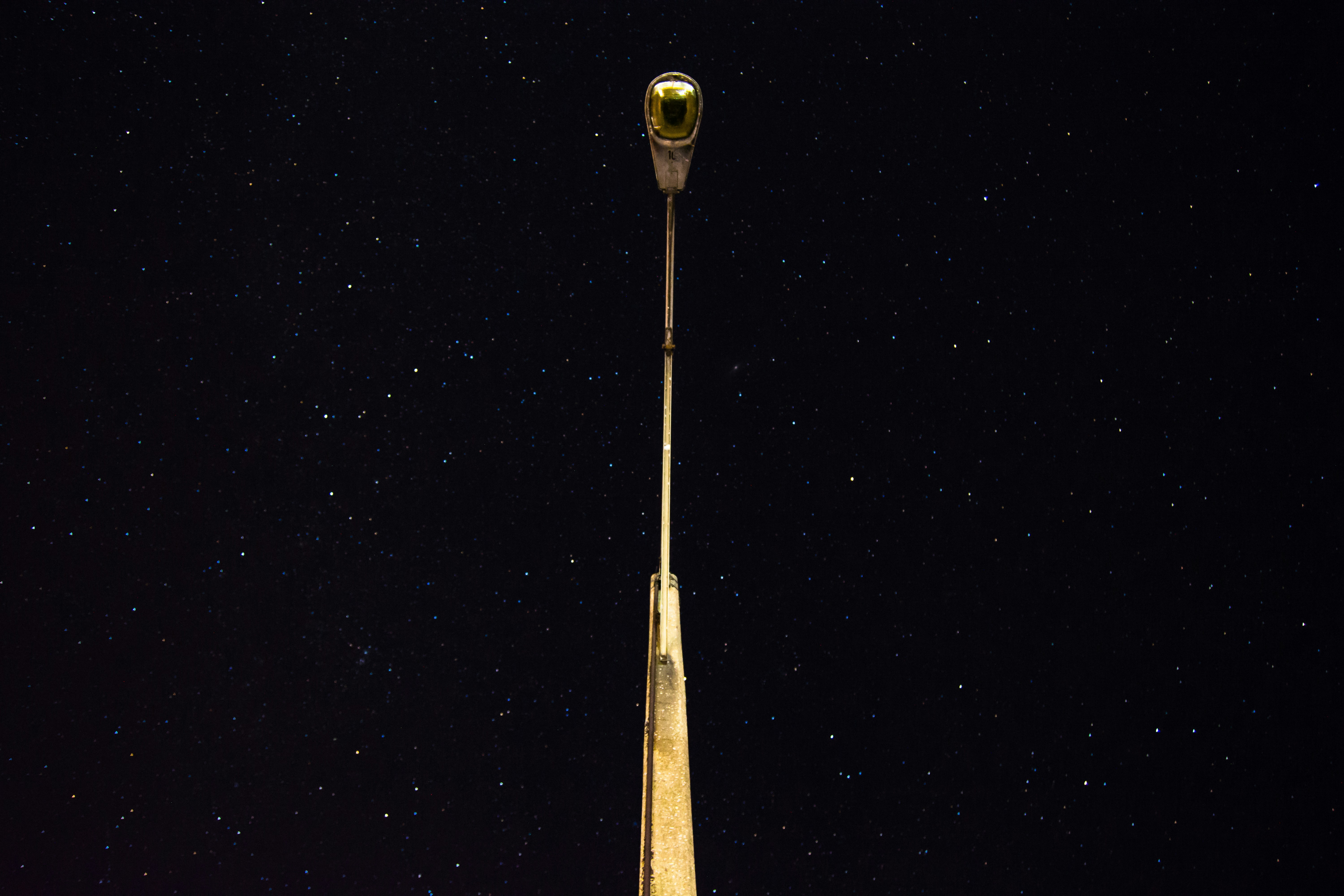 Lone Streetlight Piercing a Starry Night