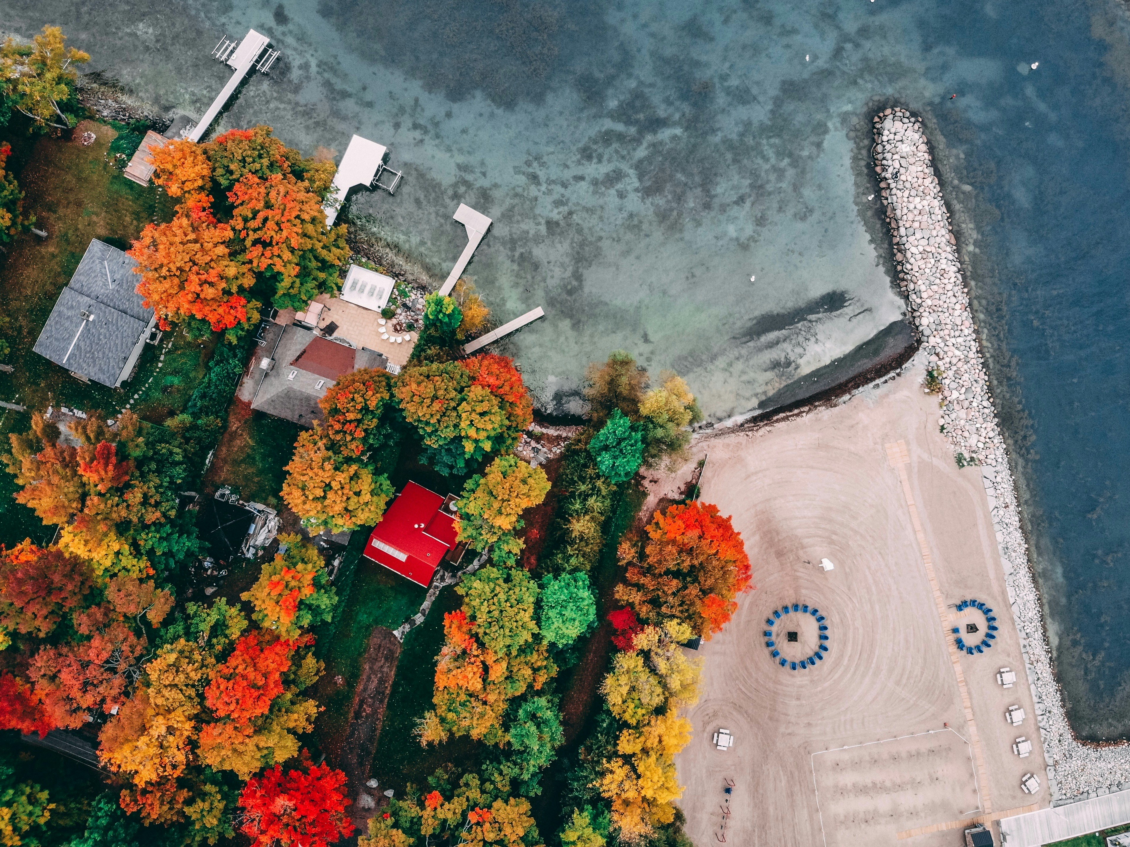 Red Roof Refuge: Autumn Village Framed by a Quiet Coastal Bend