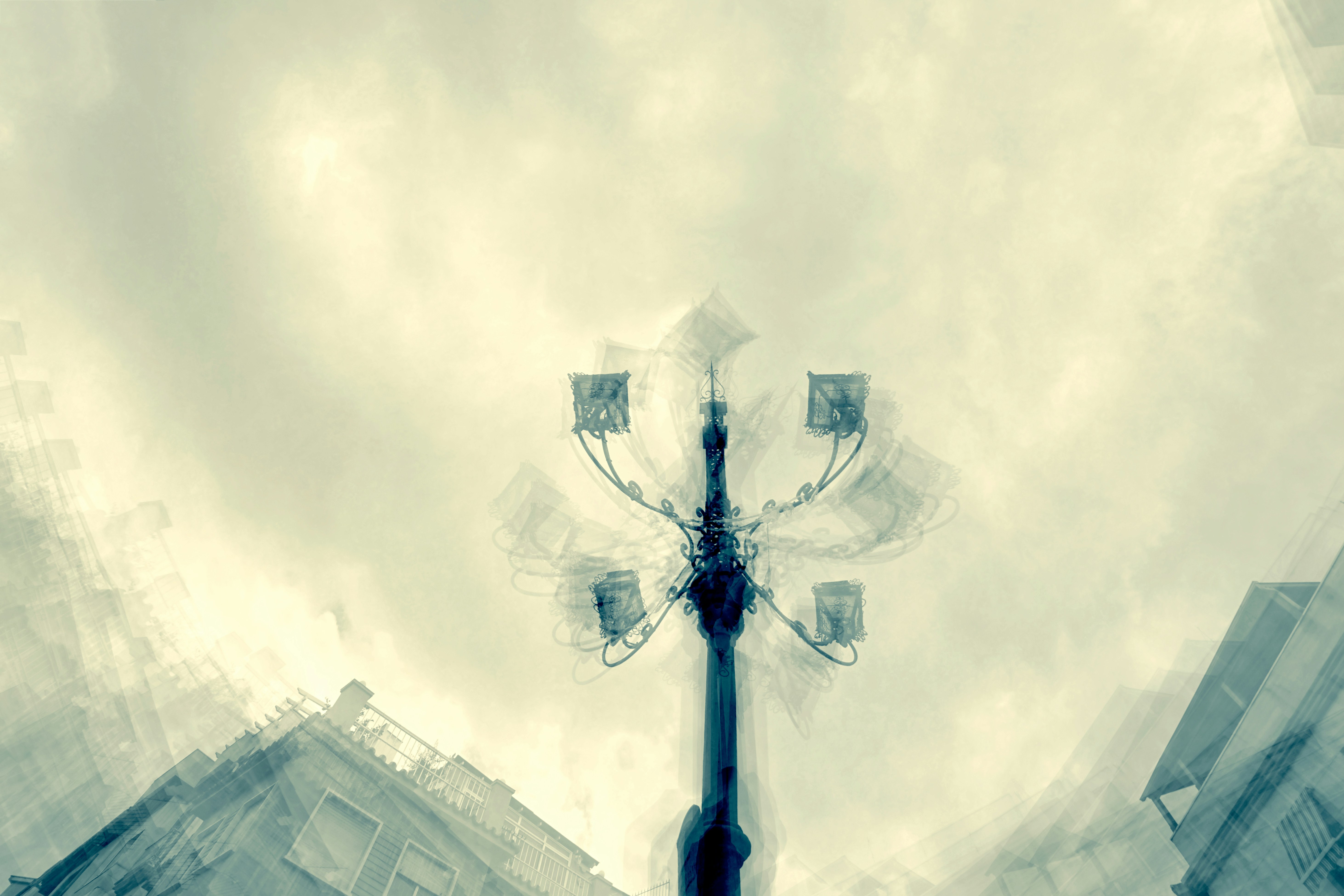 Abstract view of a streetlamp with a swirling effect against a cloudy sky.