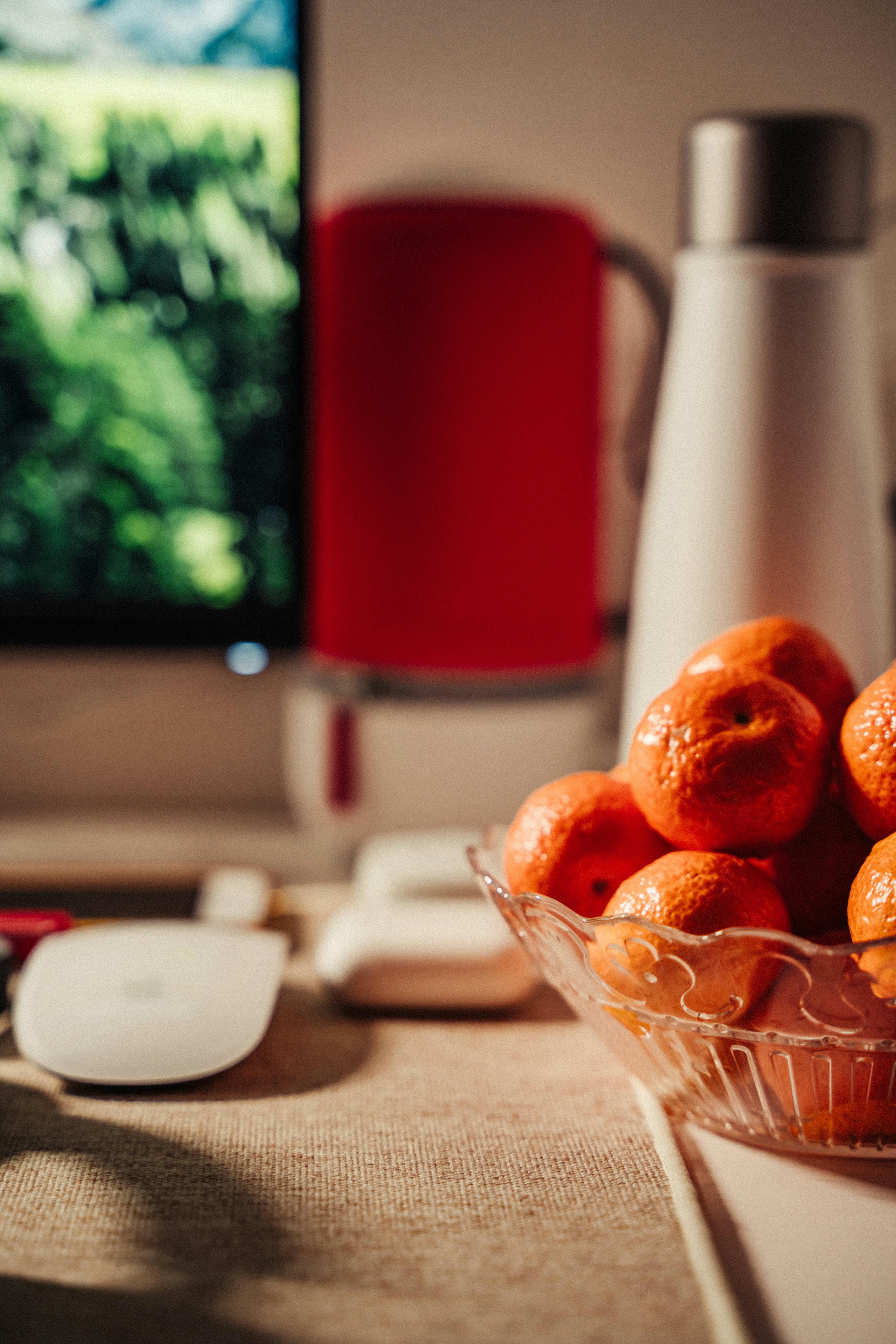 Citrus Calm at a Desk: Oranges on Glass Dish with Kitchen Gear in Focus
