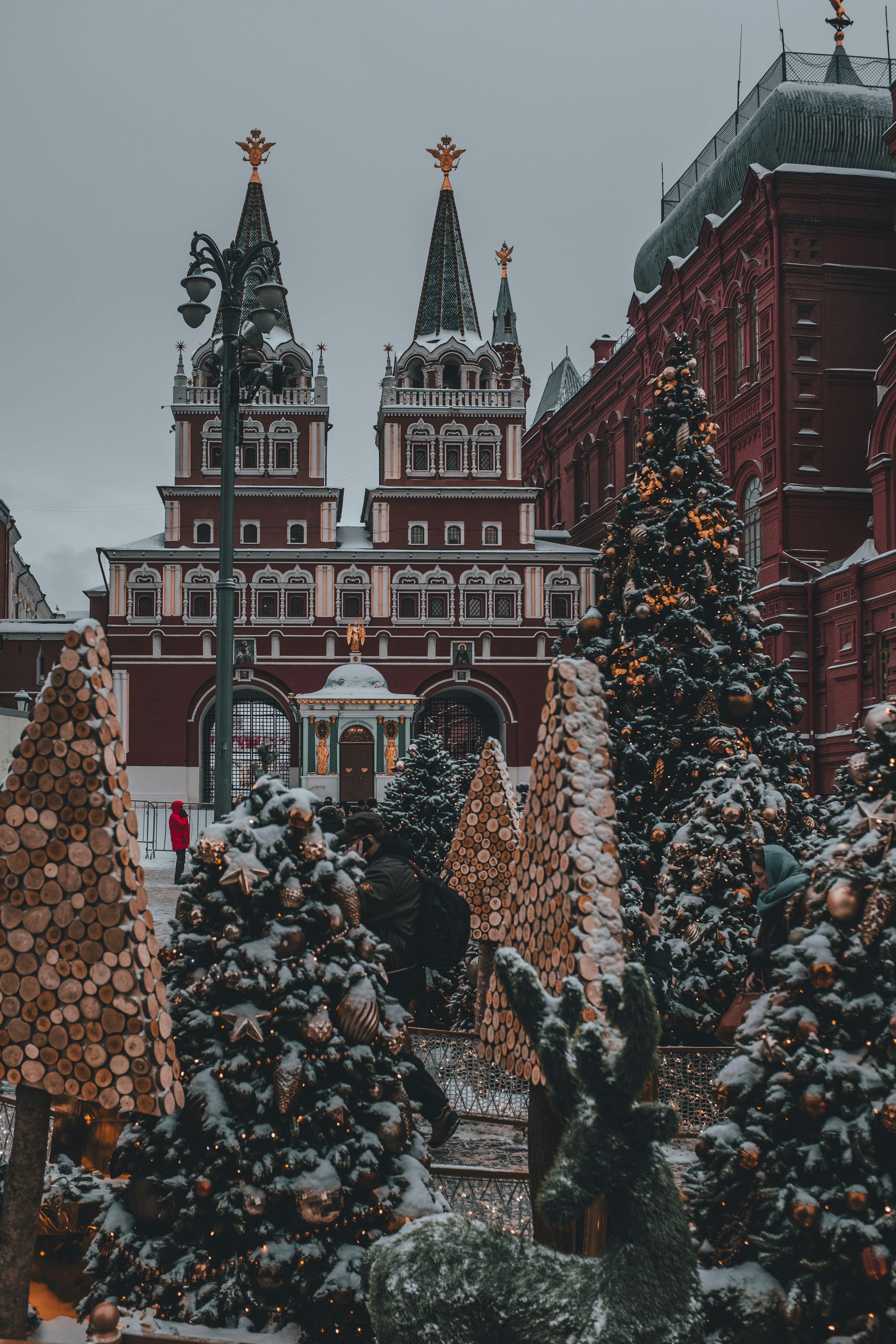 Maroon building with trees surrounding under gray sky photo – Free Grey ...