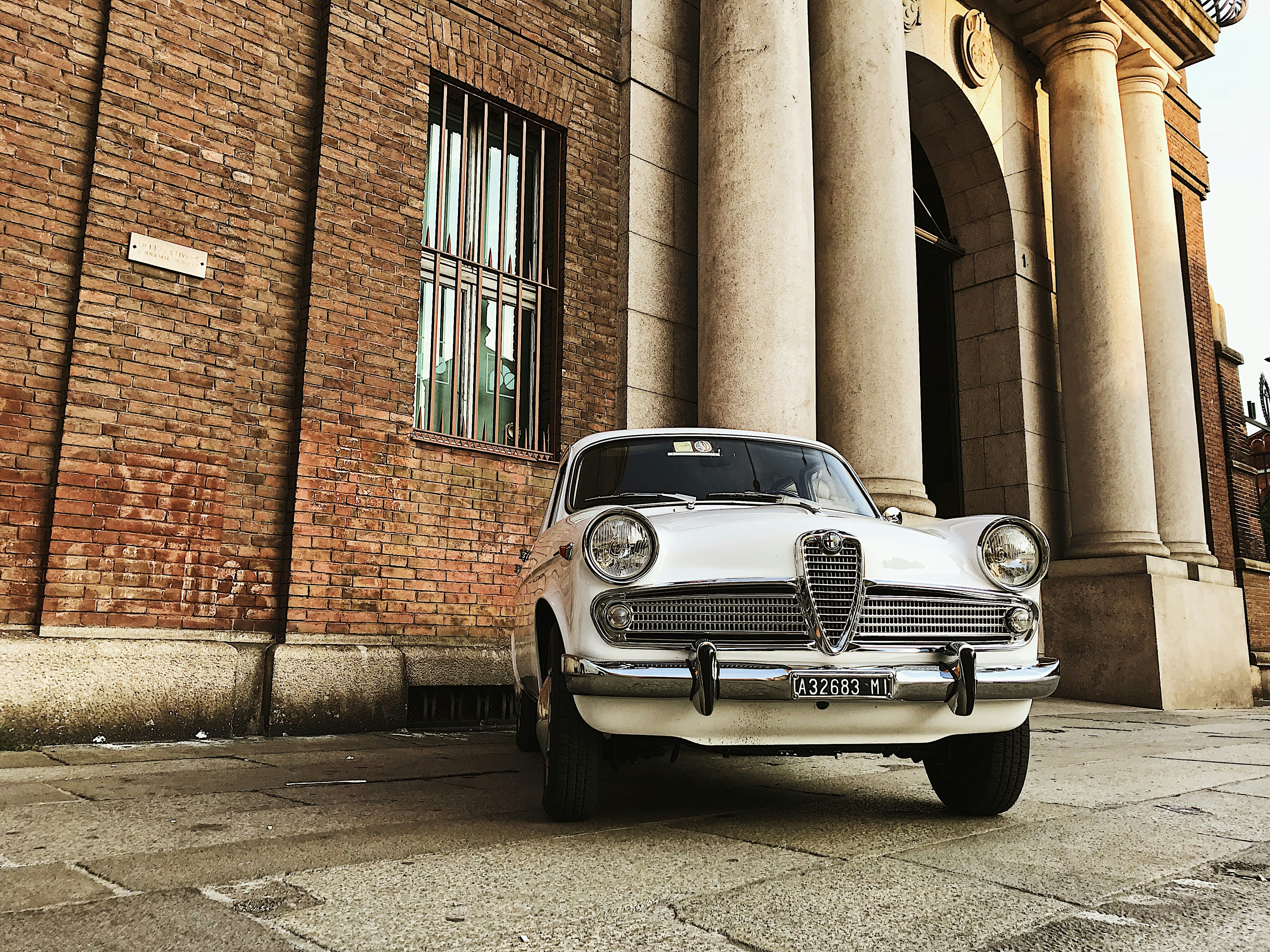 White Alpha Romeo car parked near building photo – Free Machine Image ...