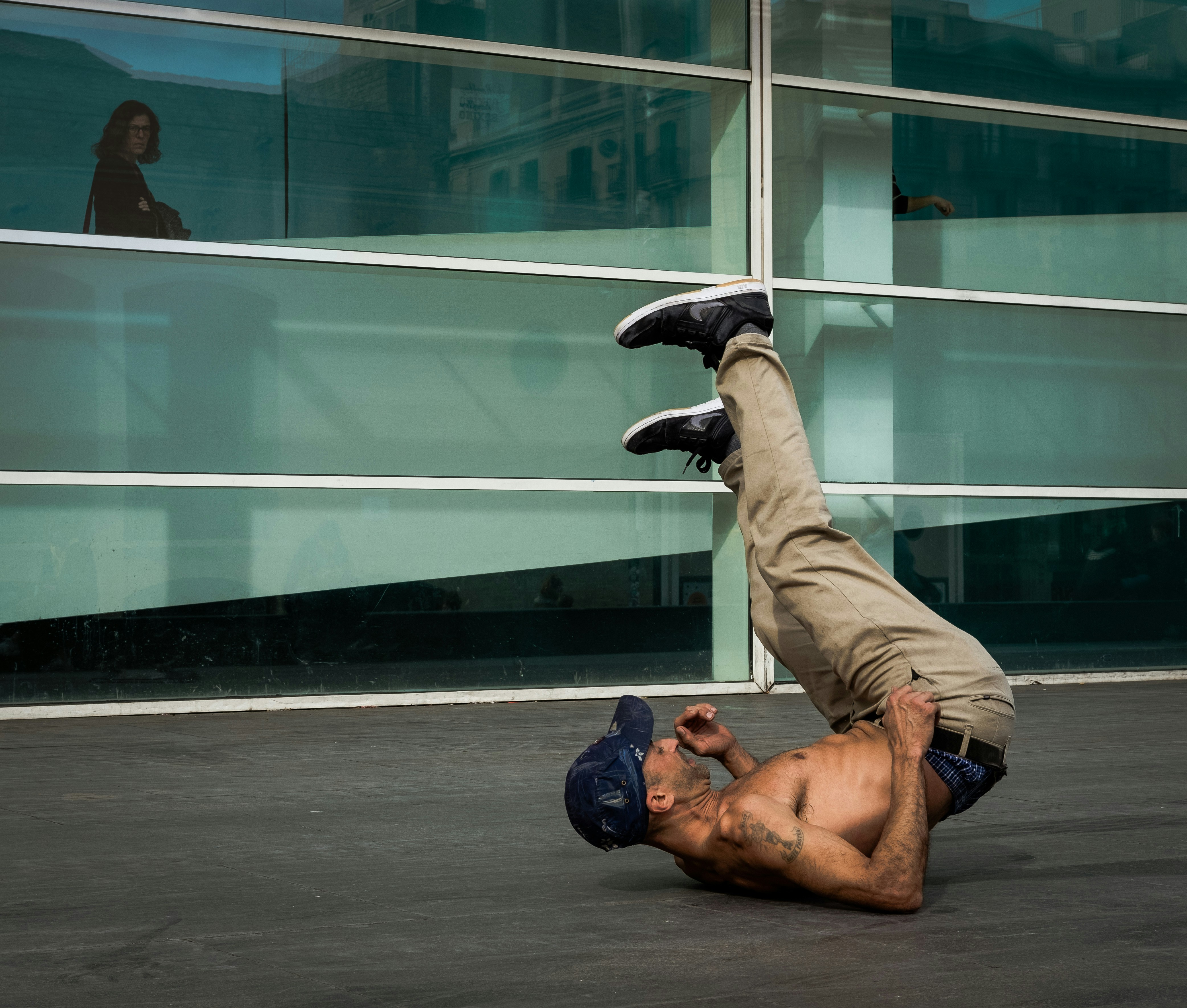 Gravity-Defying Breakdancer on a Glass Facade Stage