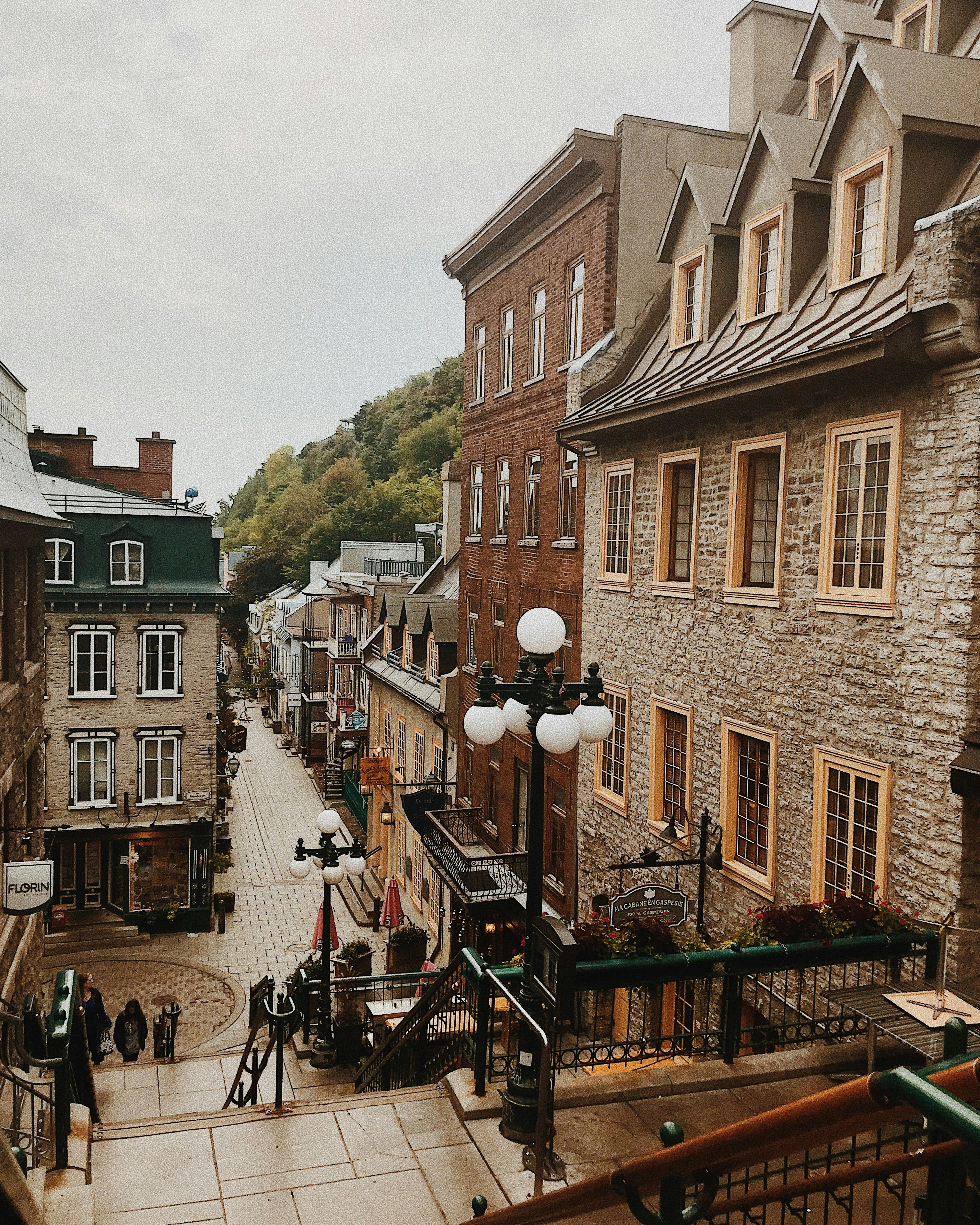 People walking on stairs surrounded by building during daytime photo ...