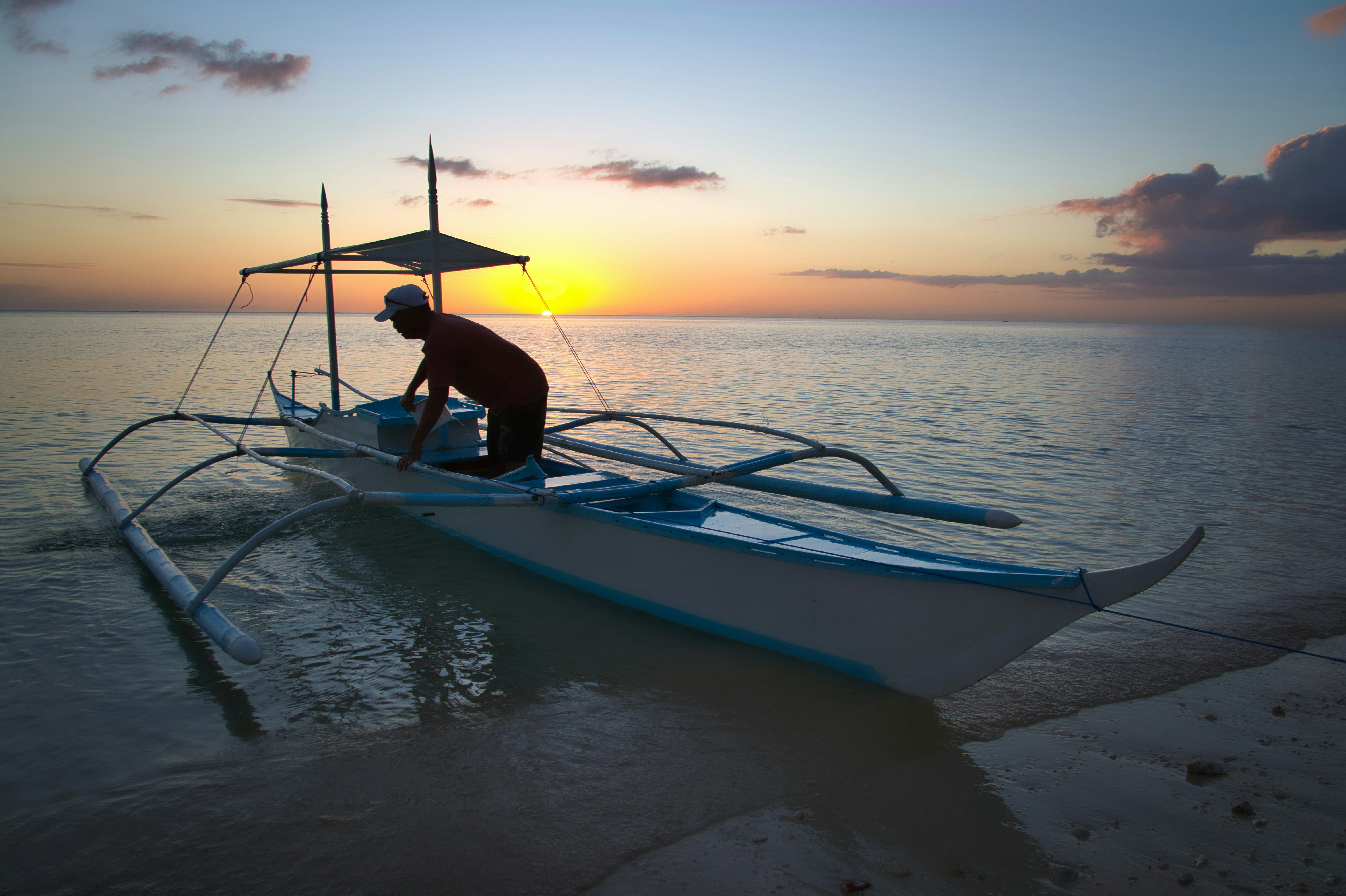Twilight Outrigger: A lone sailor and the sun's last whisper