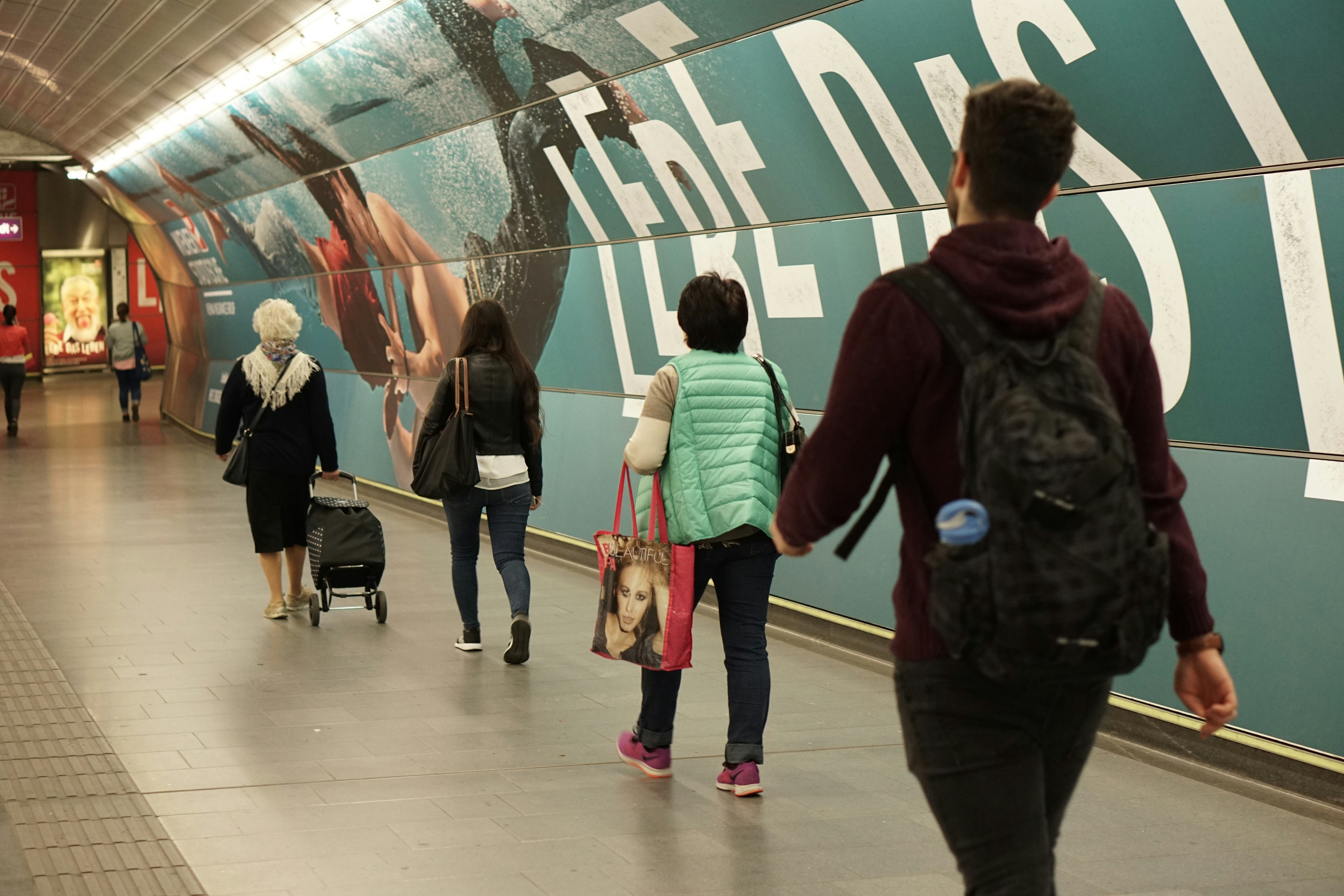 Four people walking on hallway photo – Free People Image on Unsplash