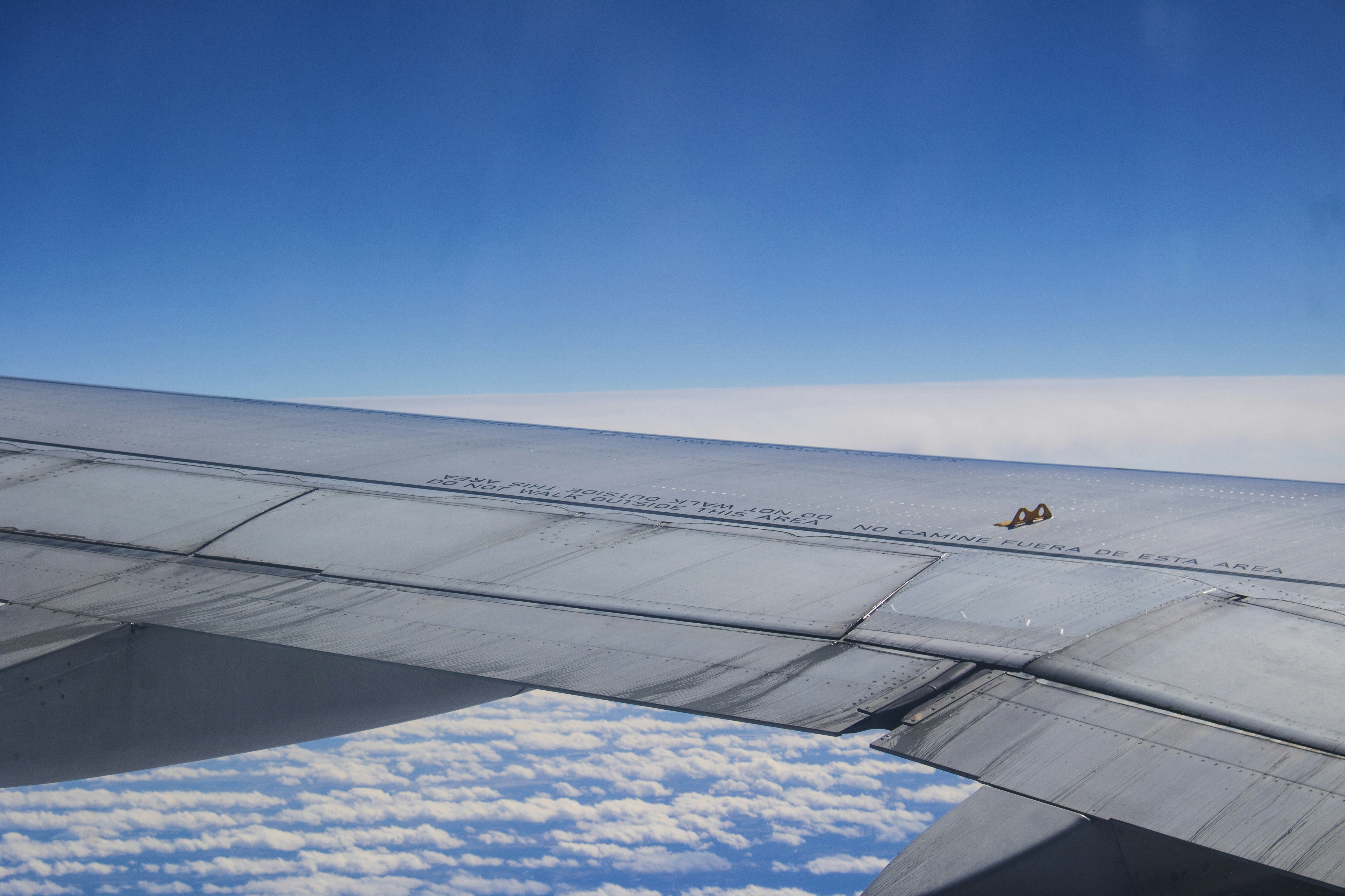 a view of the wing of an airplane in the sky