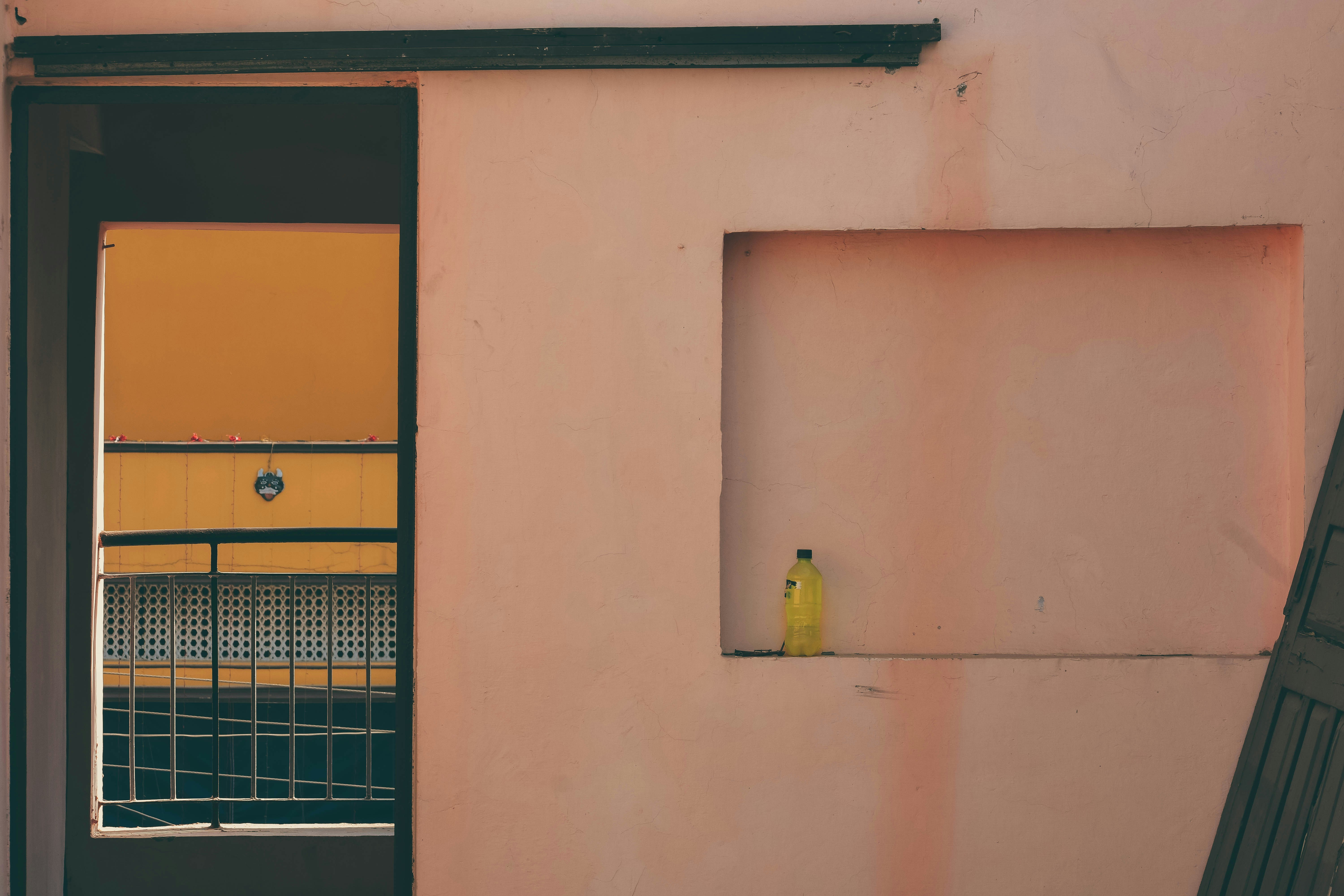 Muted Geometry: A Bottled Moment on a Peach Wall