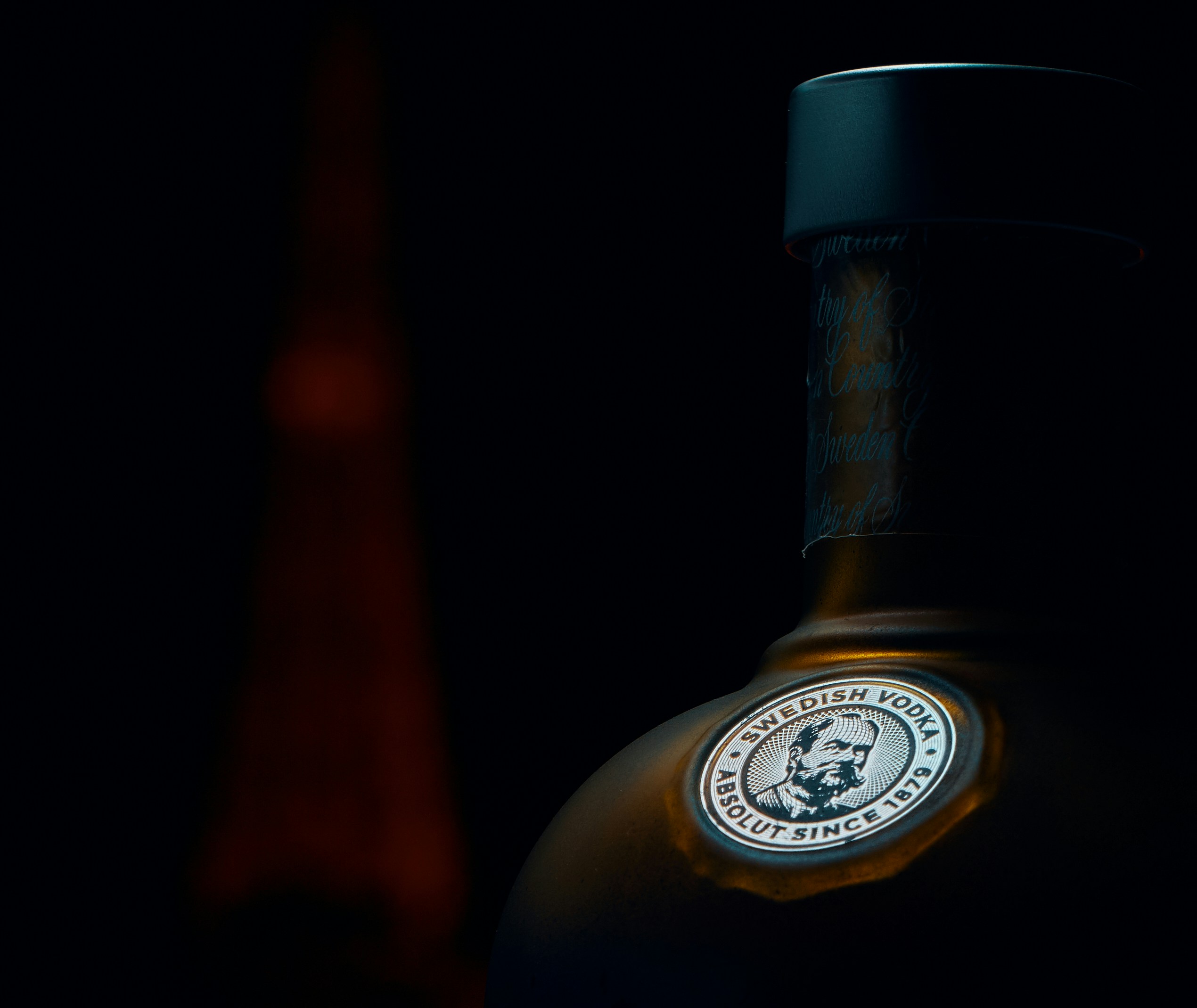 a bottle of liquor sitting in the dark