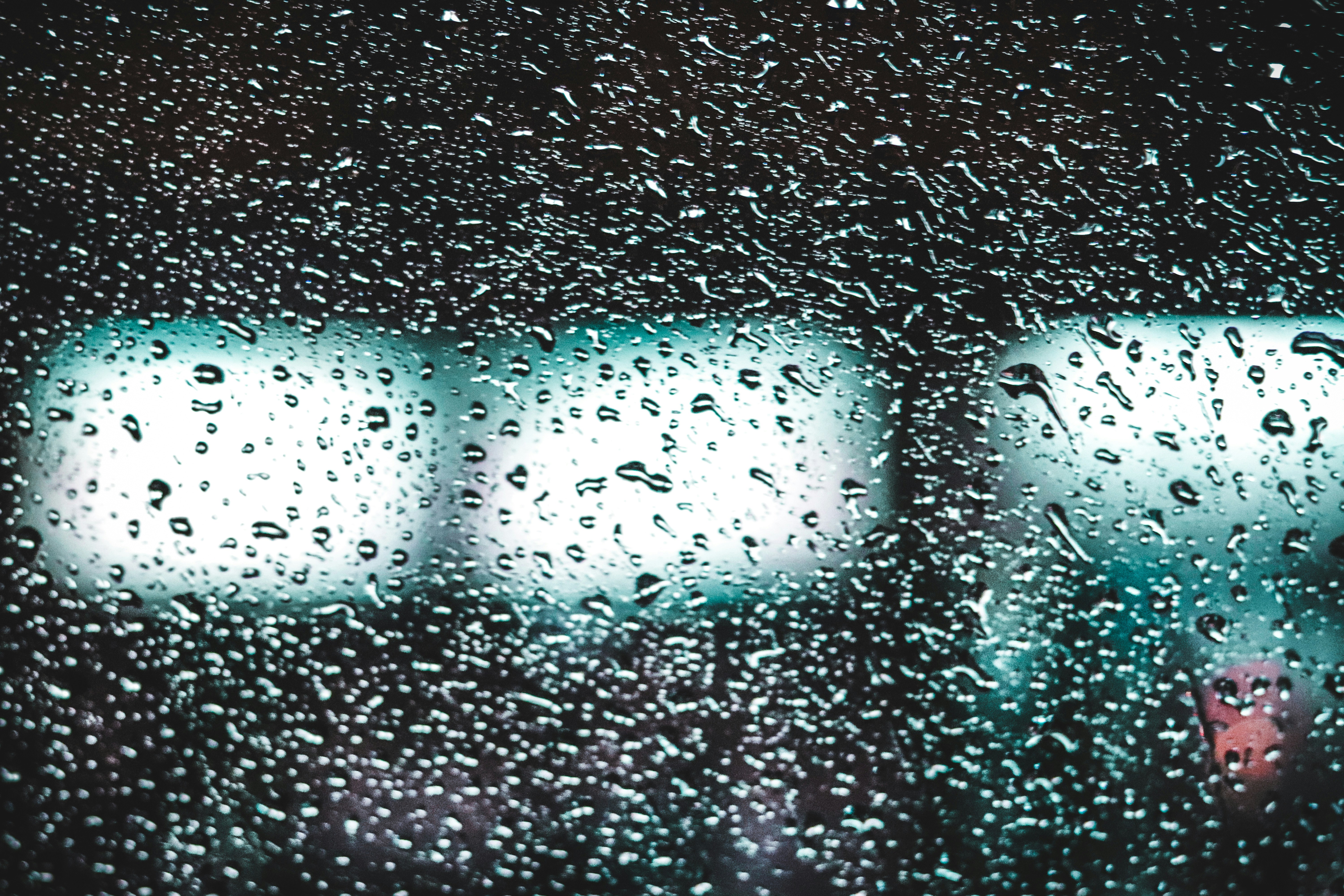 Neon Reflections Through Rain-Splashed Glass