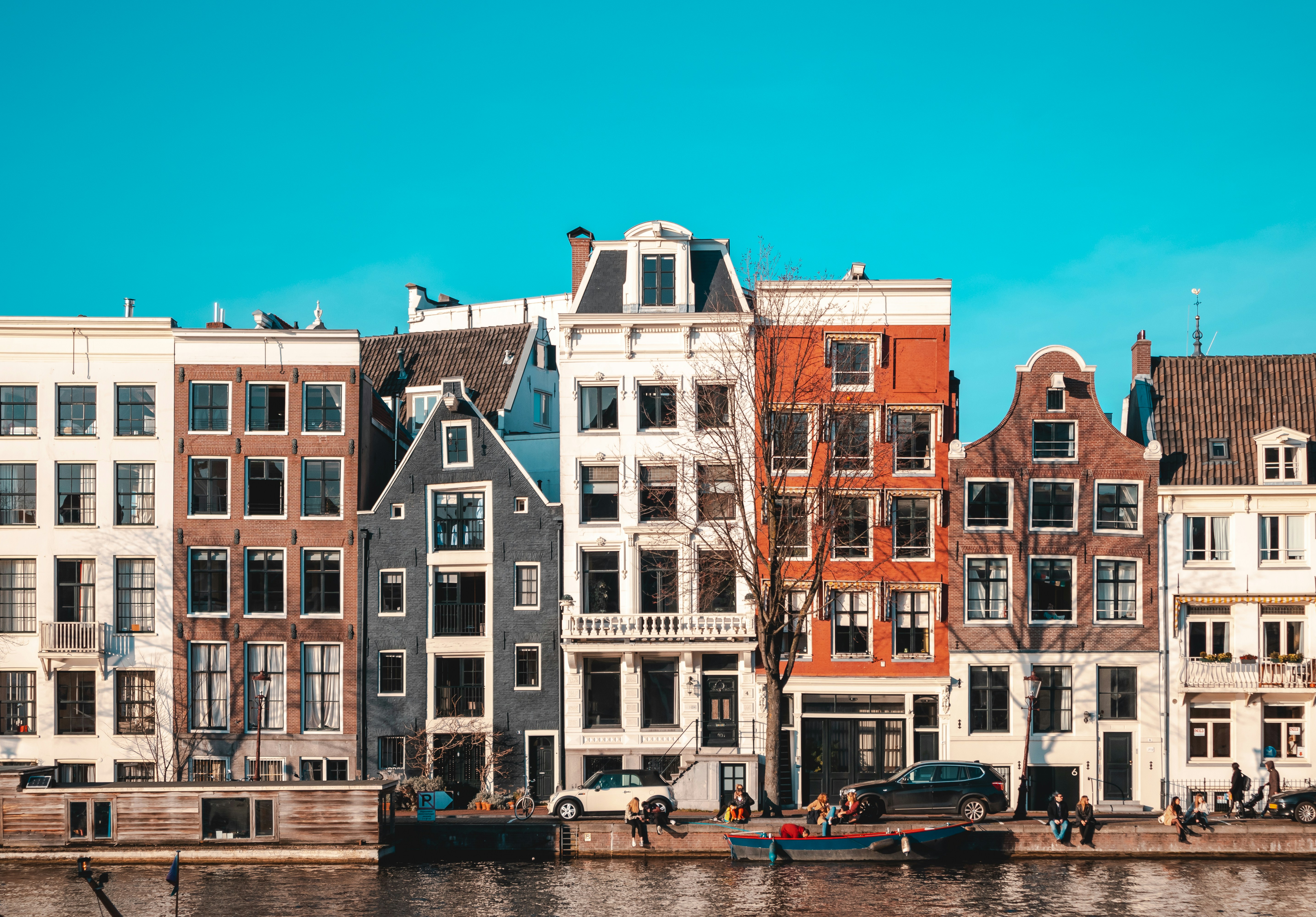 Concrete buildings near river photo – Free Canal Image on Unsplash