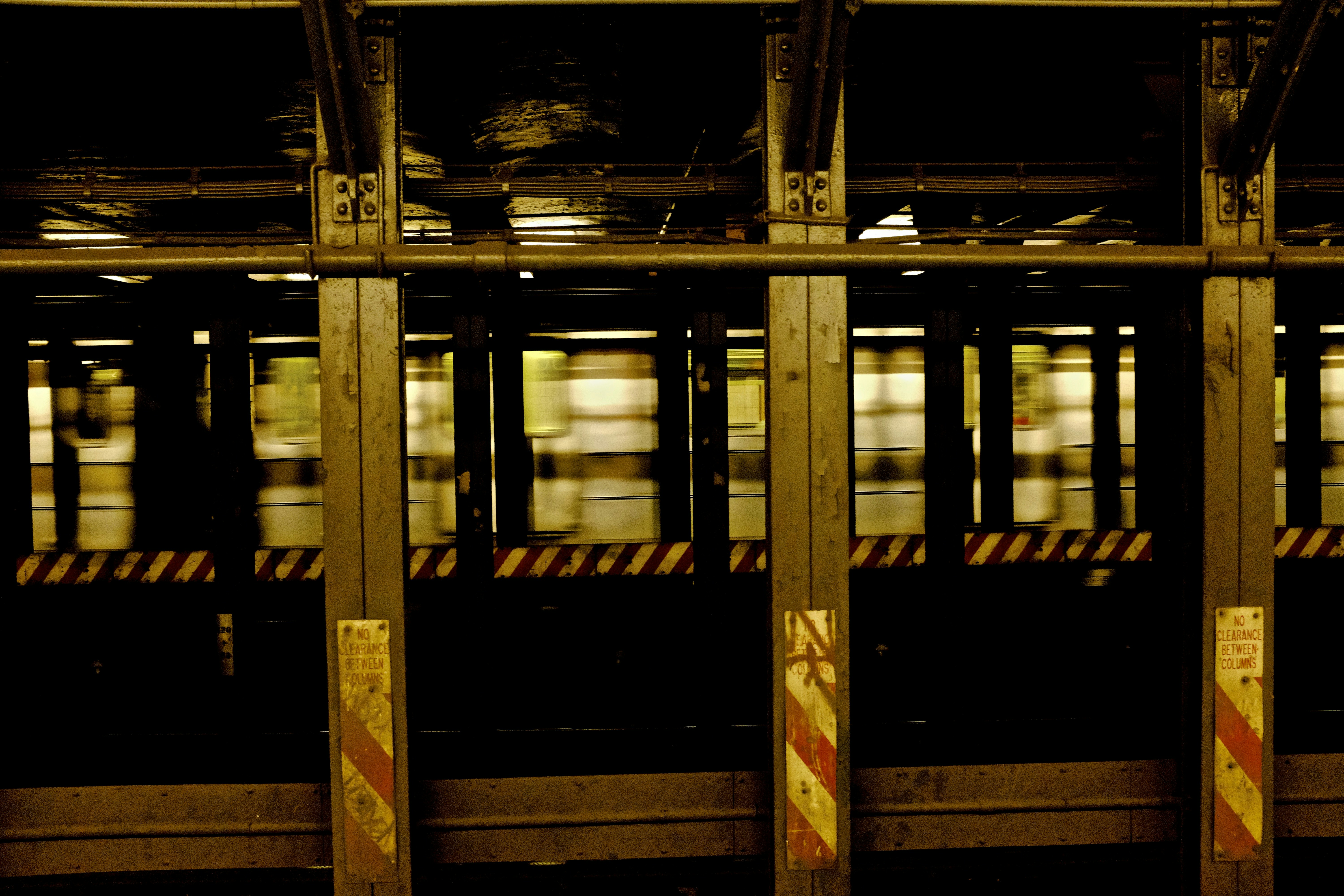 Midnight Platform: Blurred Train Through Striped Columns