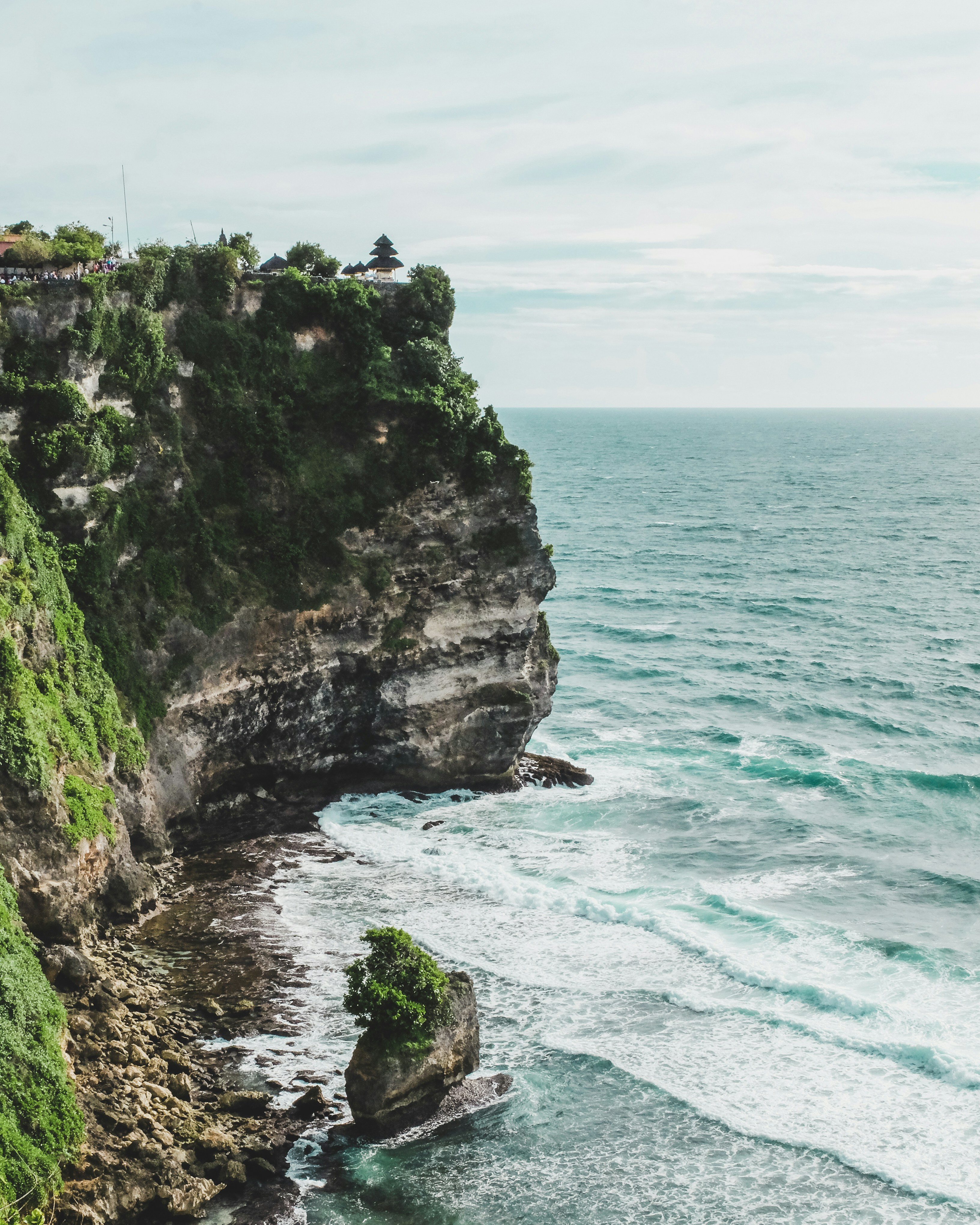 Green trees on grey cliff near seawater photo – Free Grey Image on Unsplash