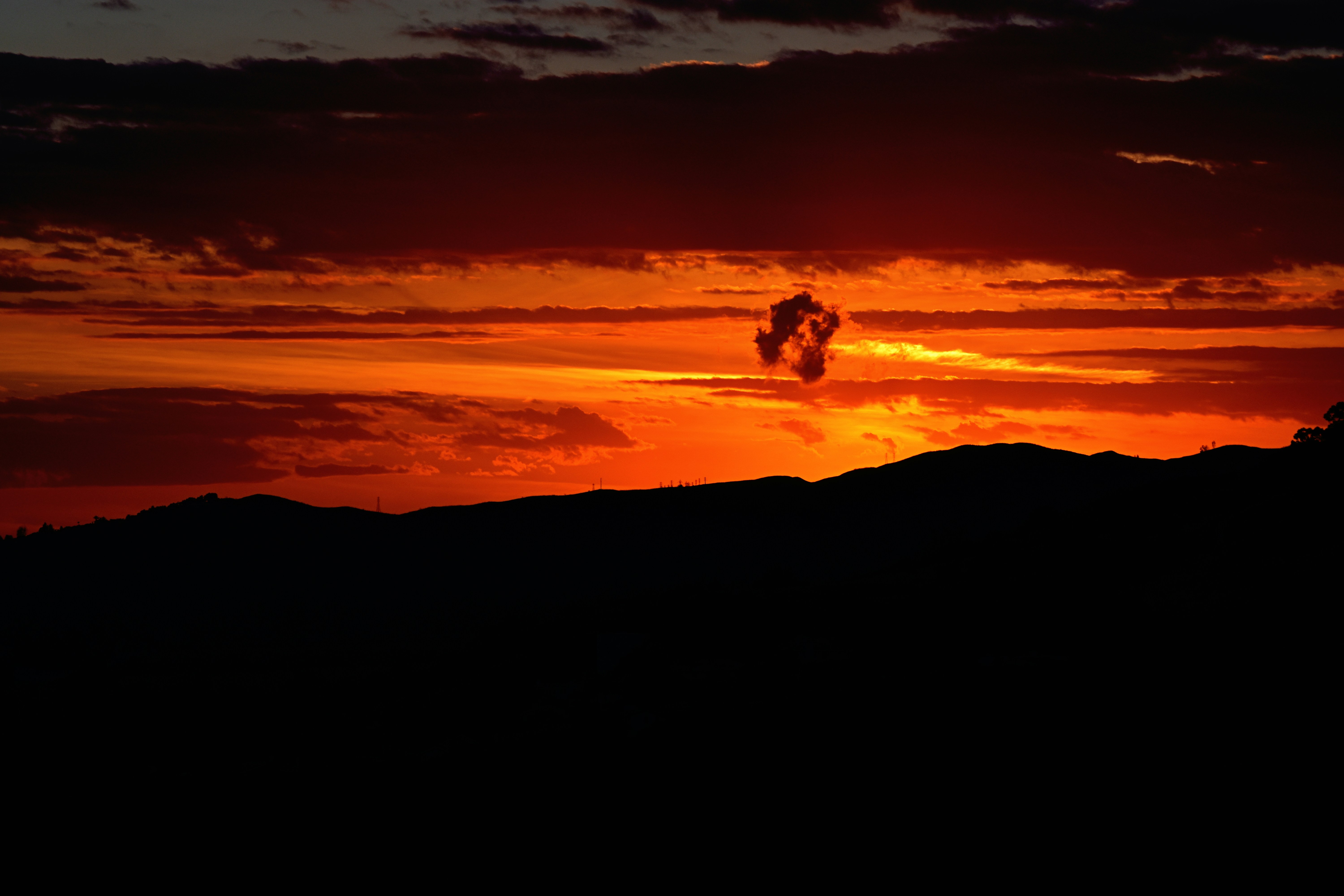 Fiery horizon over a silent ridge at dusk