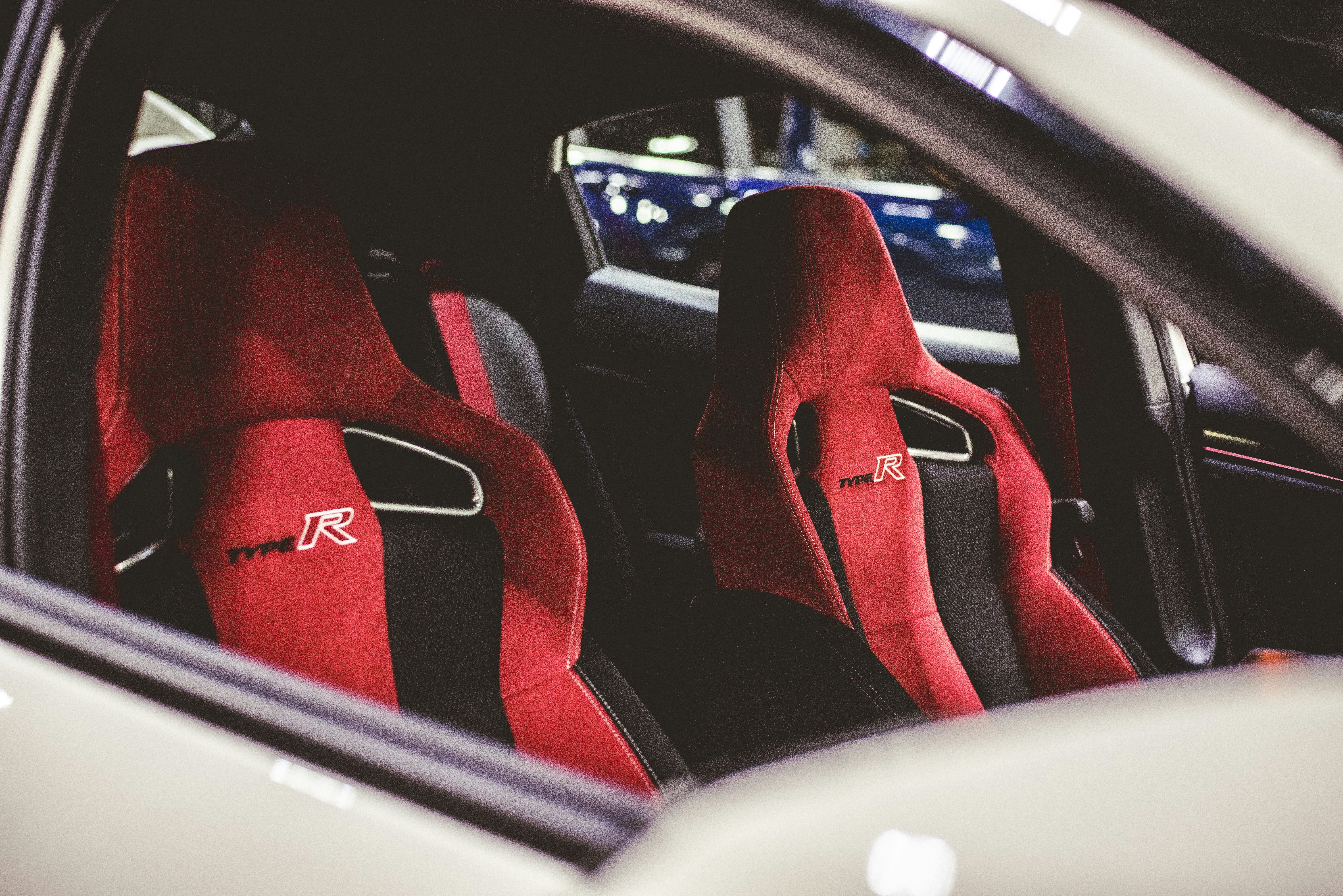 Red Racing Seats in a White Coupe: A Studio Inside View