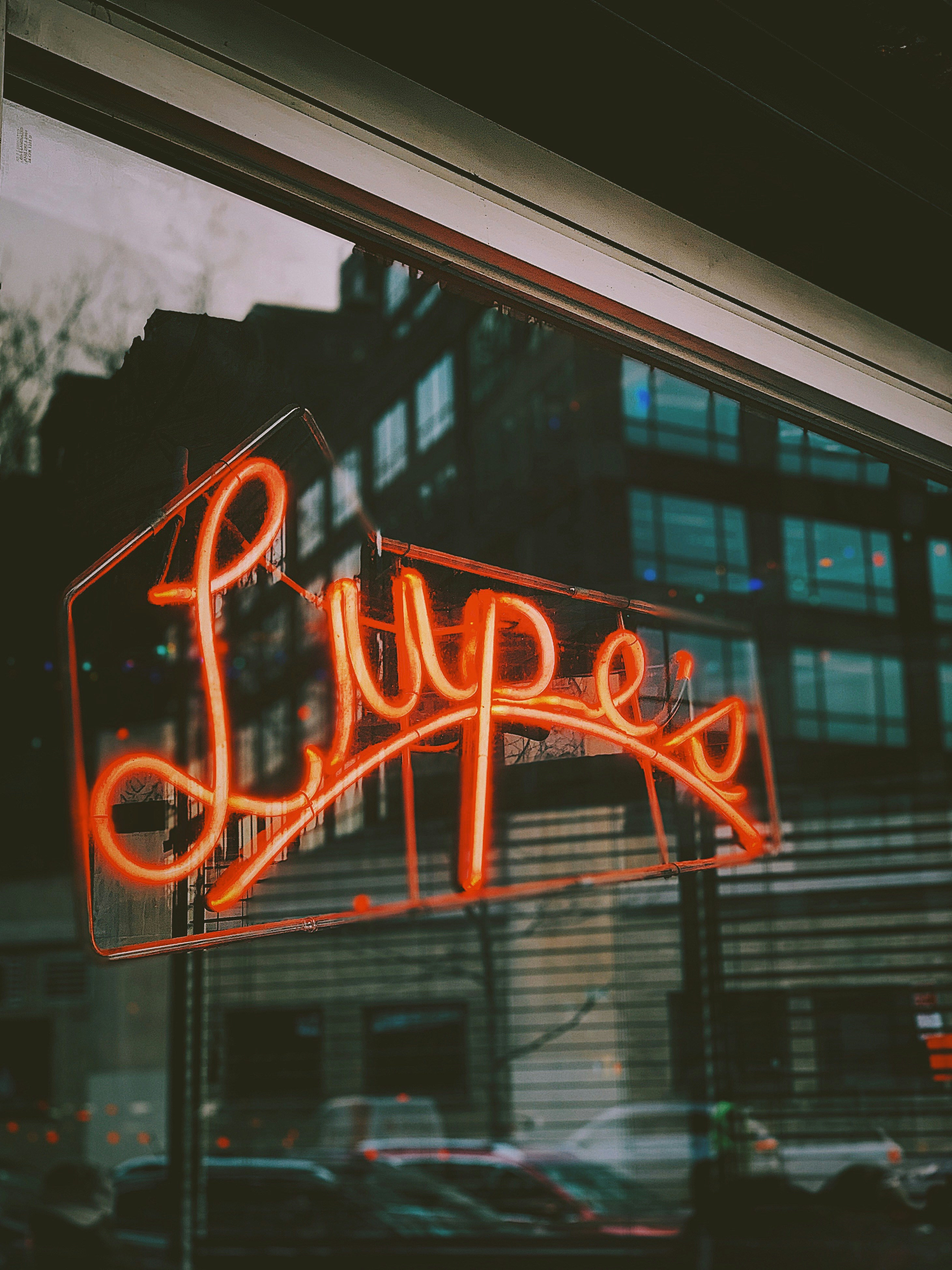Neon Sign in a City Window: Glowing Script in the Evening