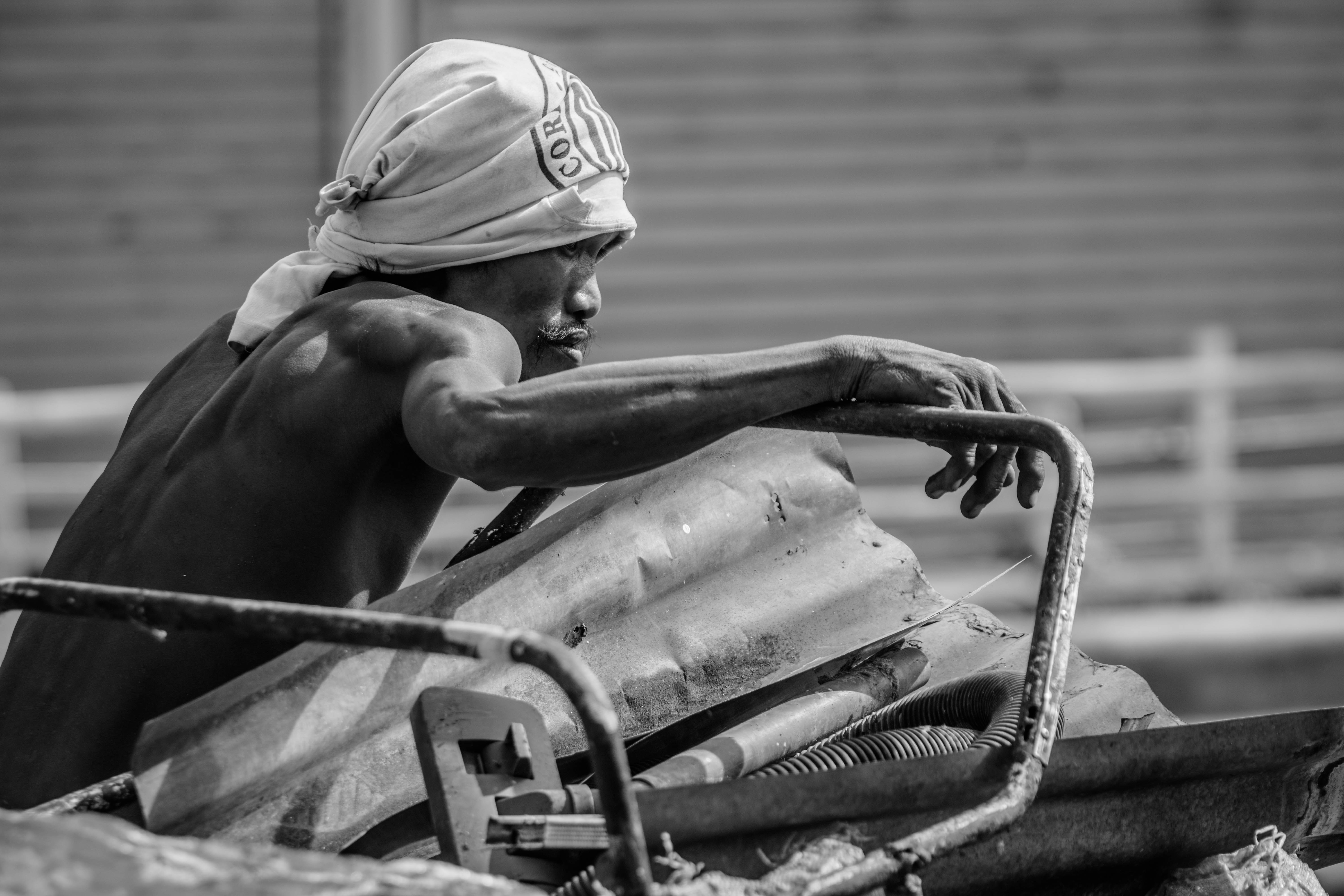 Man wearing headdress near roller shutters photo – Free Human Image on ...