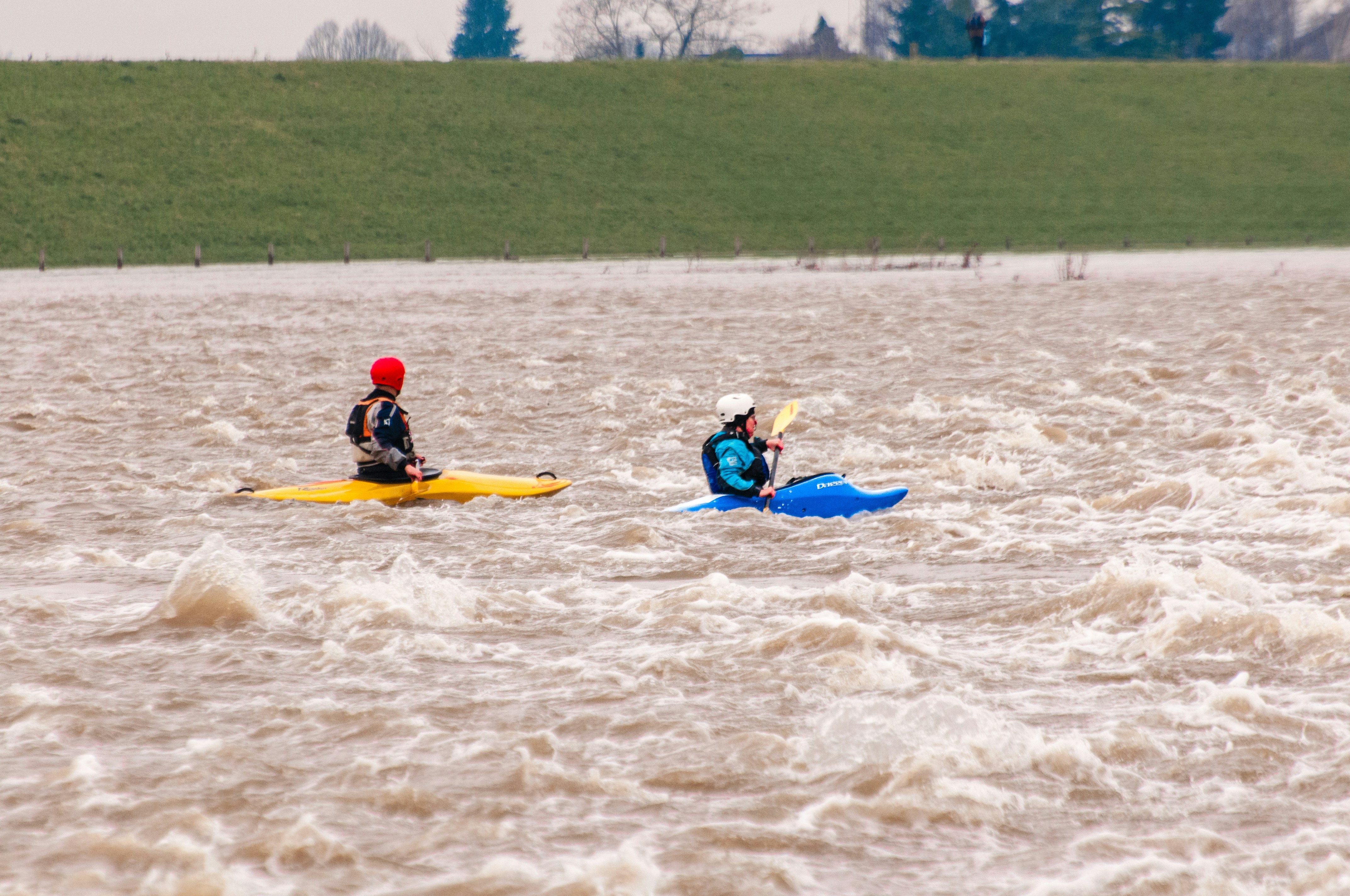 2 person riding yellow kayak on water during daytime