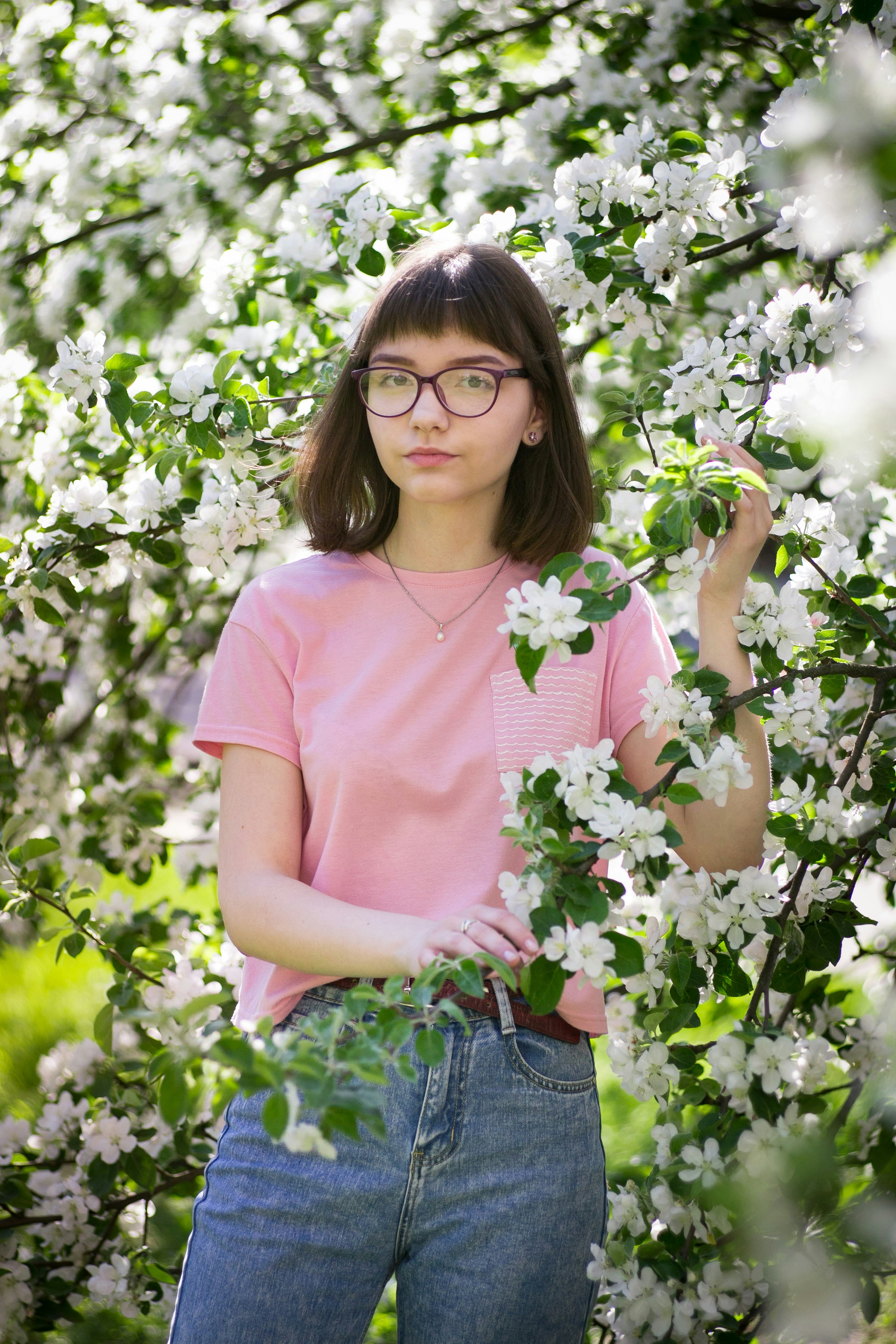 Pink-Tee Portrait Amid a Canopy of White Blossoms