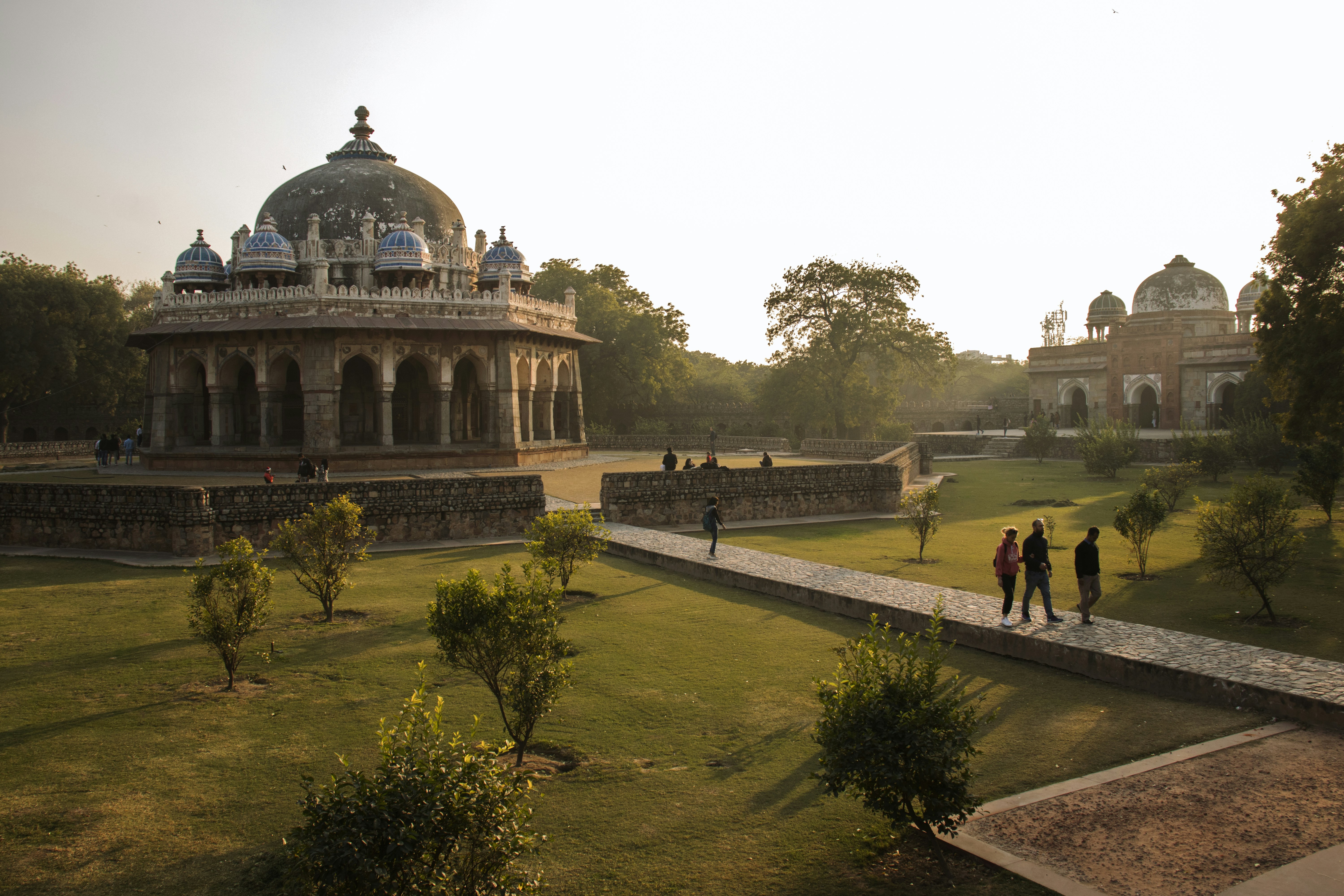 three person walking on isle during daytime